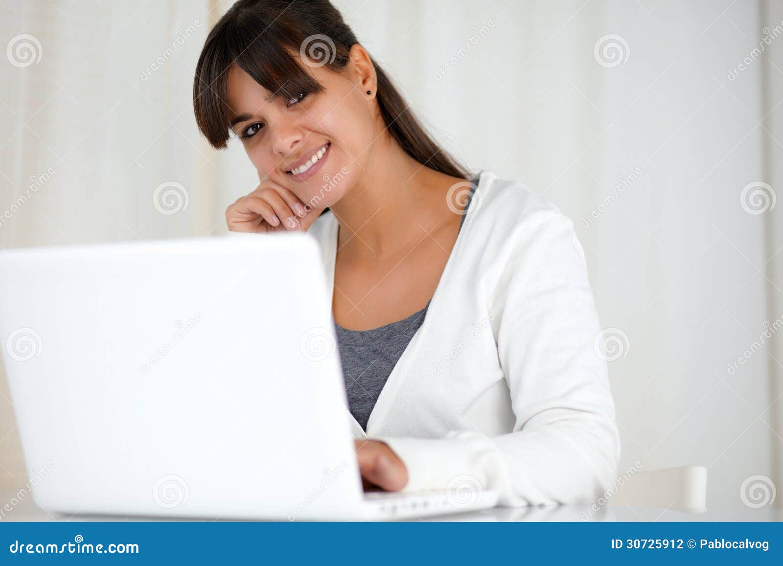 Smiling Young Woman Looking at You Using Laptop Stock Photo - Image of ...