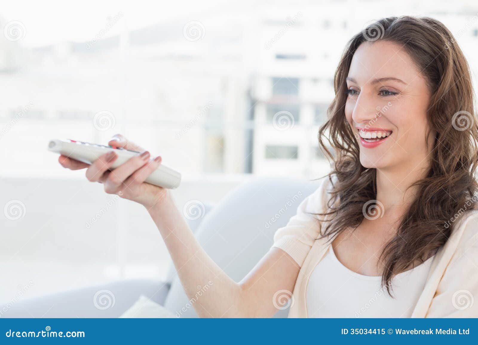 Smiling Young Woman with Remote Control Sitting on Sofa Stock Image ...