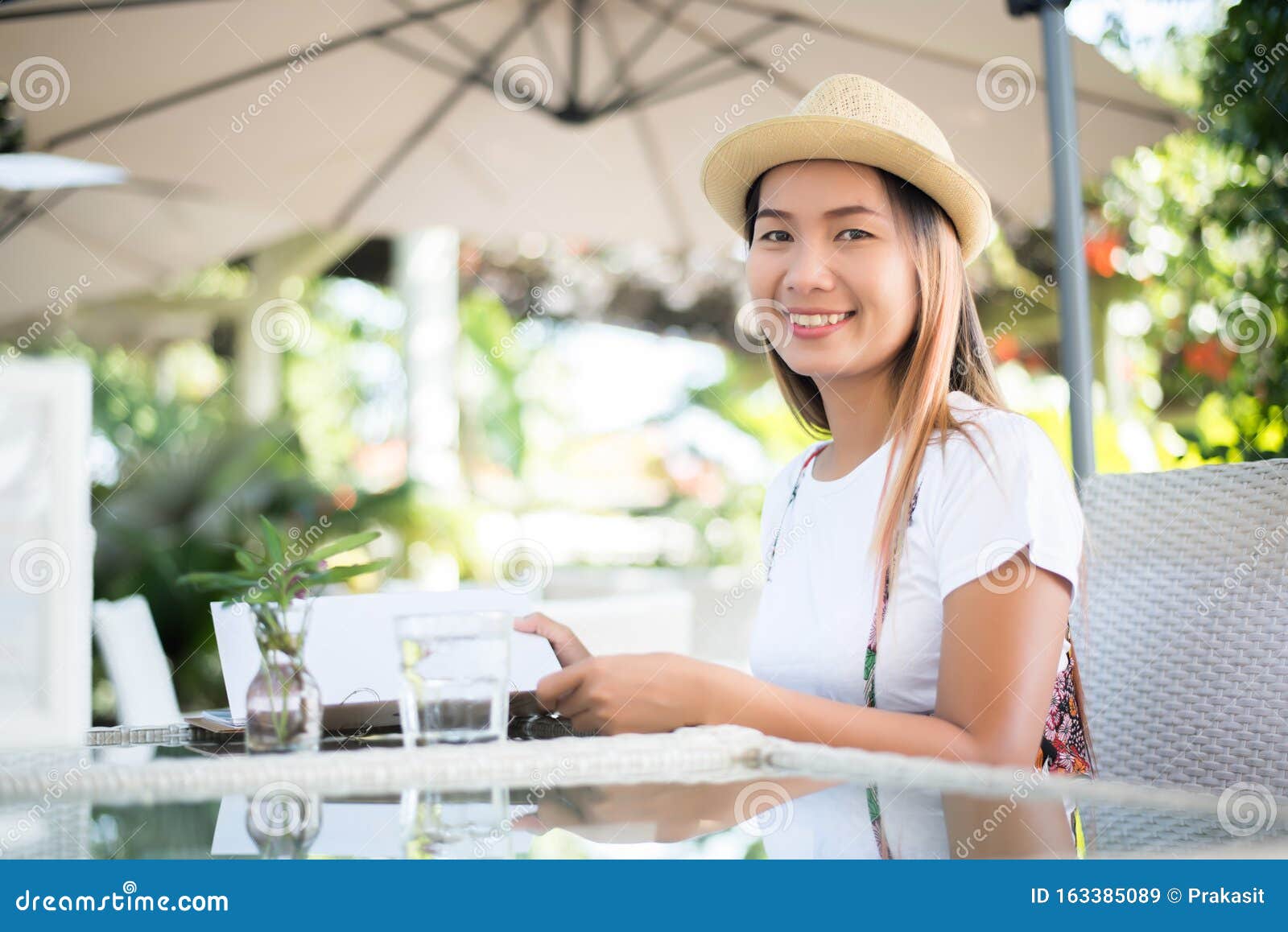 Smiling Young Woman in a Restaurant with the Menu in Hands, Young Woman ...