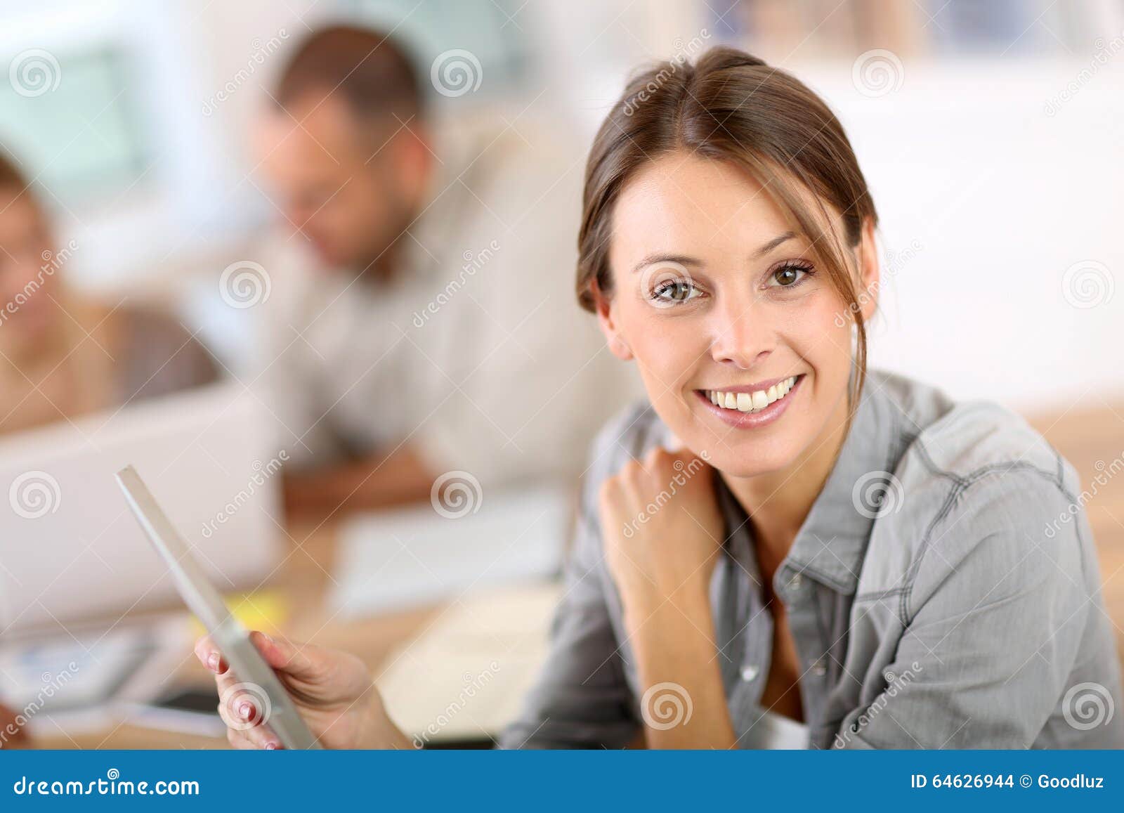 Smiling Young Woman in Training Class Using Tablet Stock Photo - Image ...