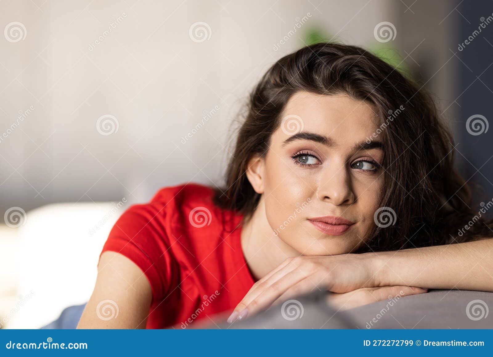 Smiling Pretty Young Woman Wearing Casual Clothes Relaxing On A Couch