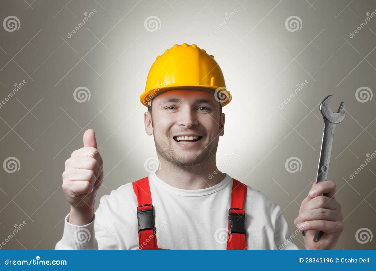 Smiling Young Worker with a Wrench Stock Photo - Image of person ...