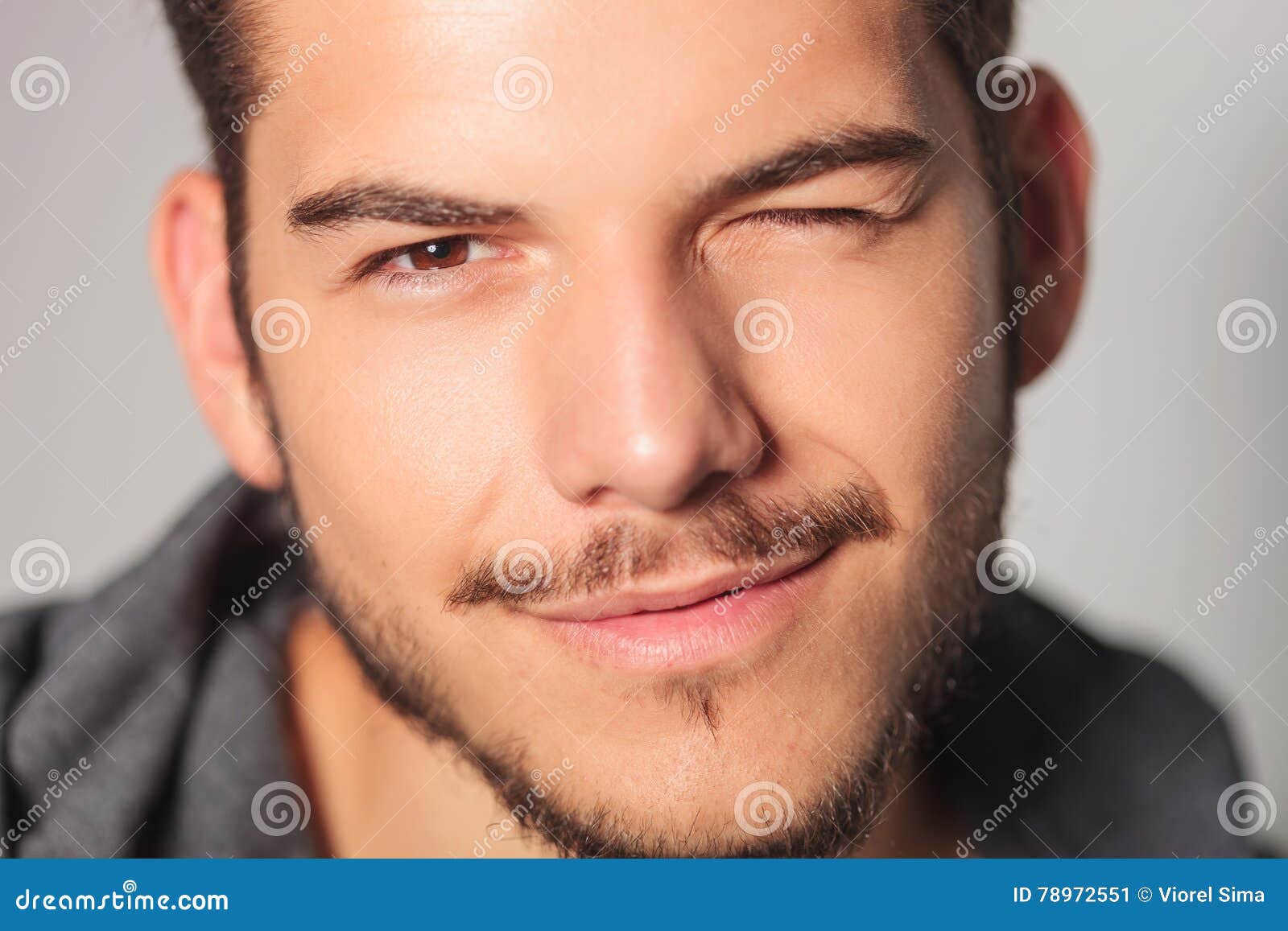 Smilling Young Man is Winking His Eye Stock Image - Image of face, male ...