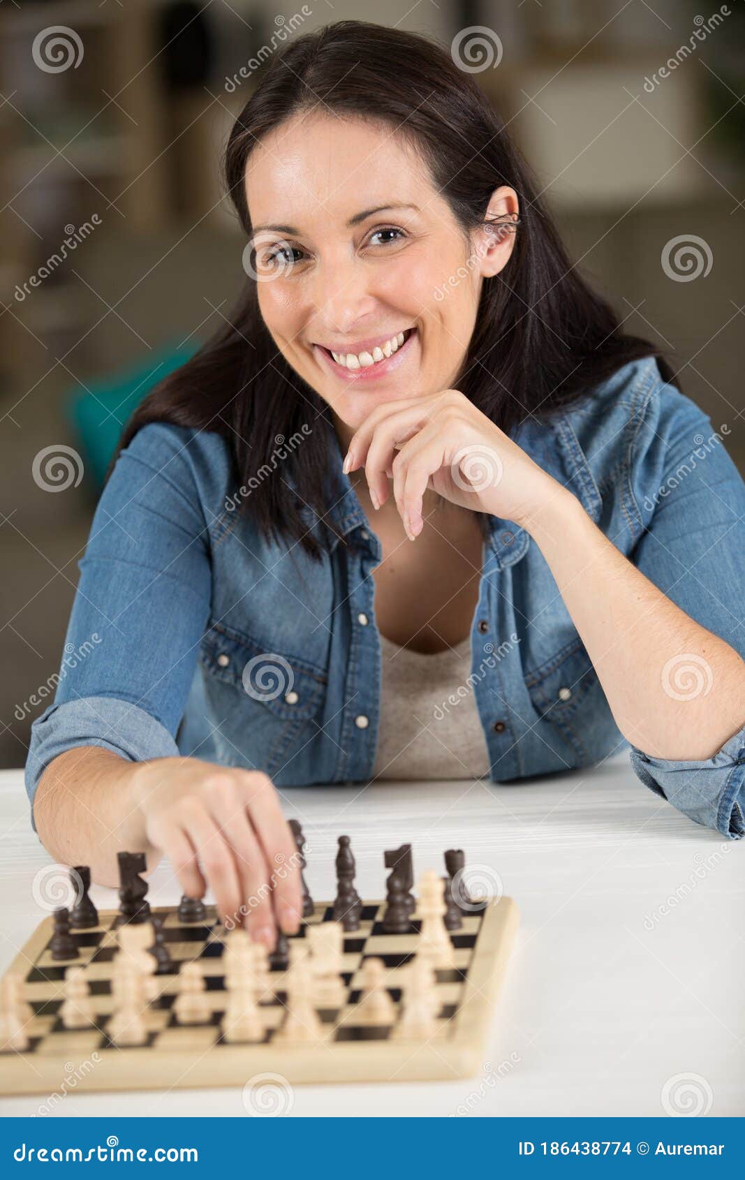 Smily woman playing chess stock photo. Image of loser - 186438774
