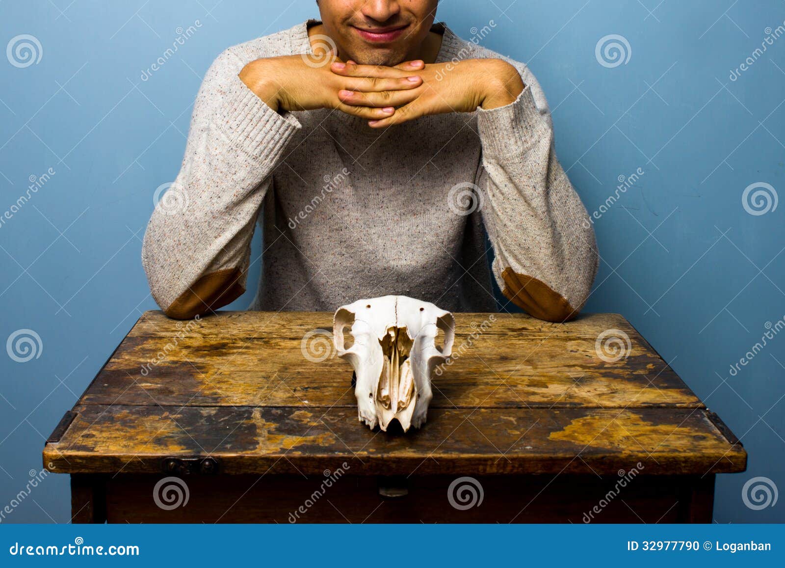 Smirking Man with Skull at Desk Stock Photo - Image of ethnic, academic ...