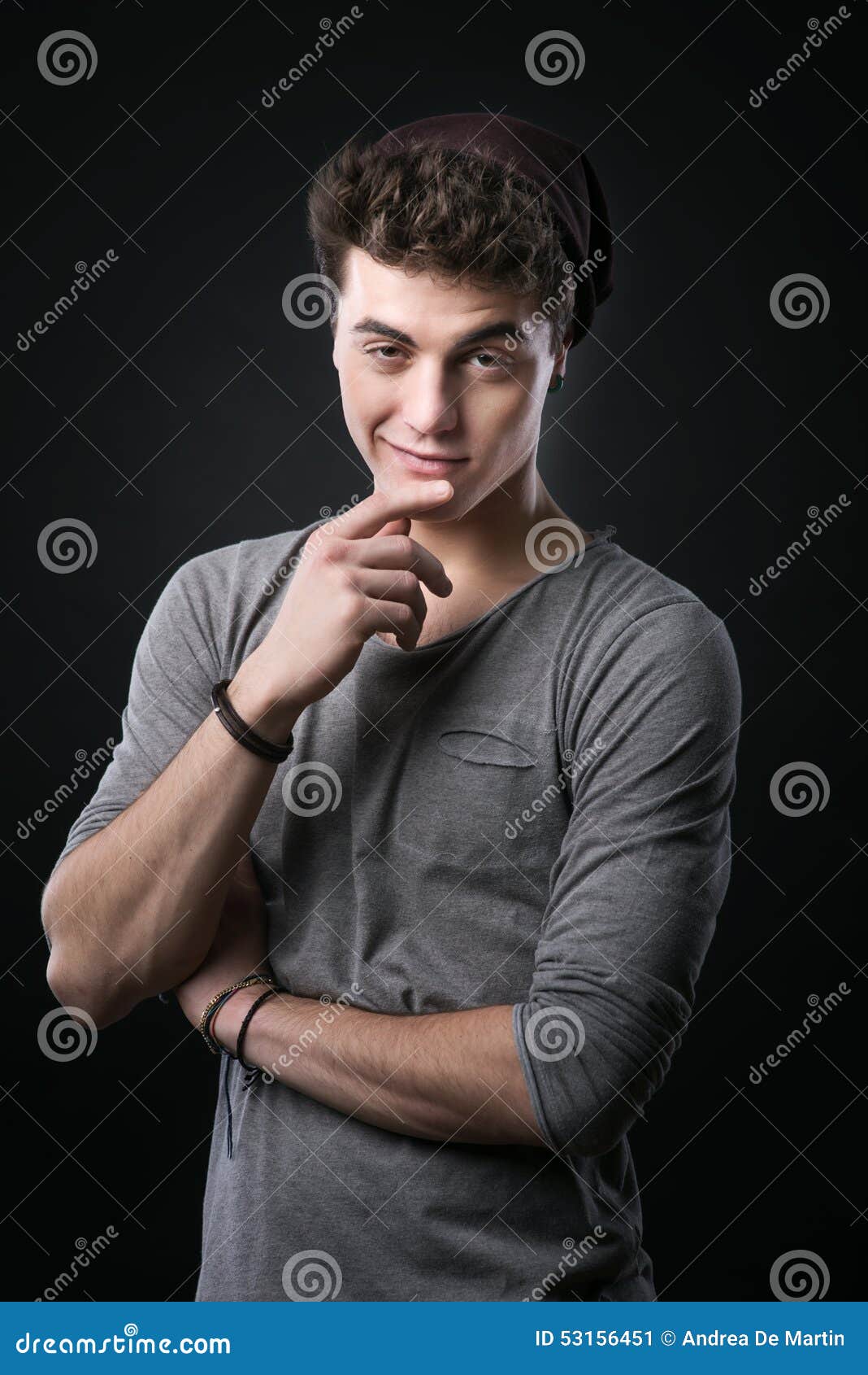 Smirking young man posing stock image. Image of dark - 53156451
