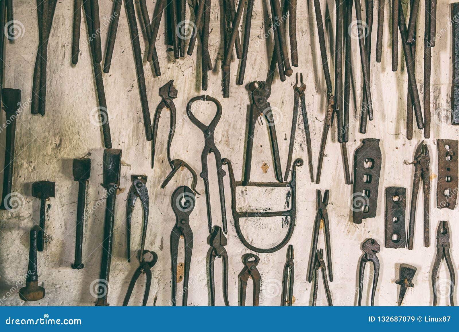 Smithy tools on the wall stock image. Image of hand - 132687079