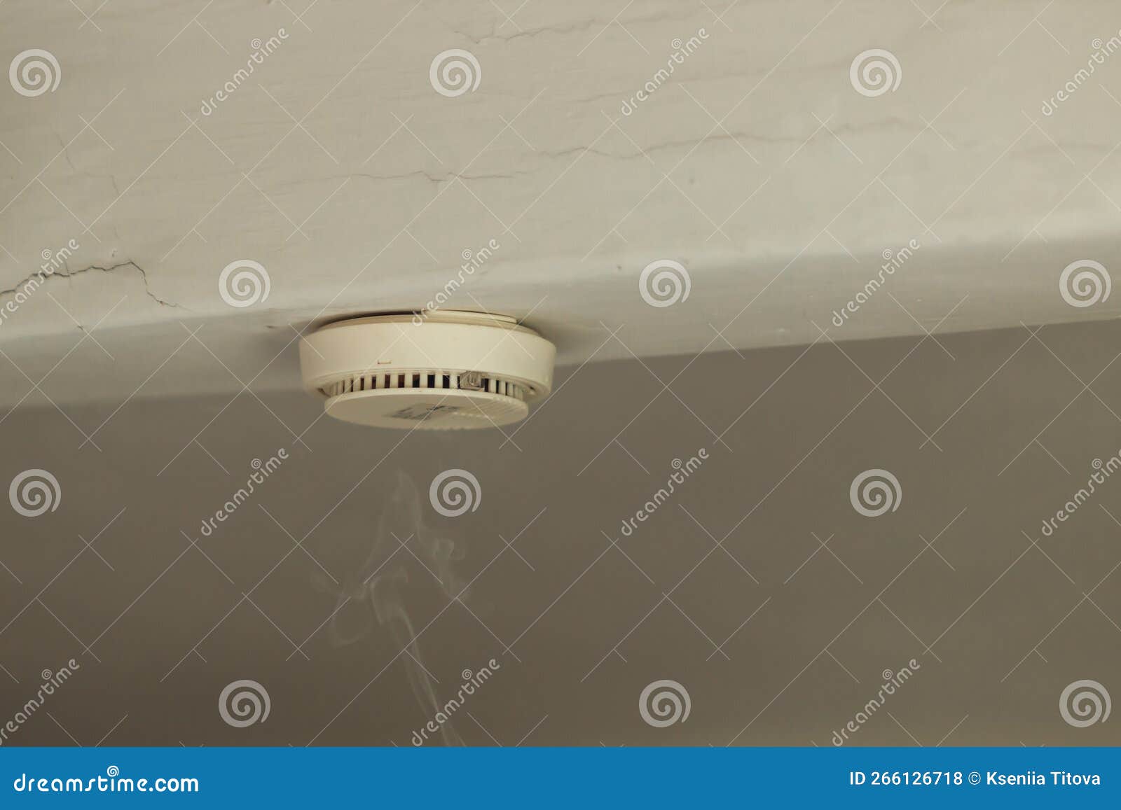 Smoke and Fire Detector on White Ceiling of Home with Smoke in the ...