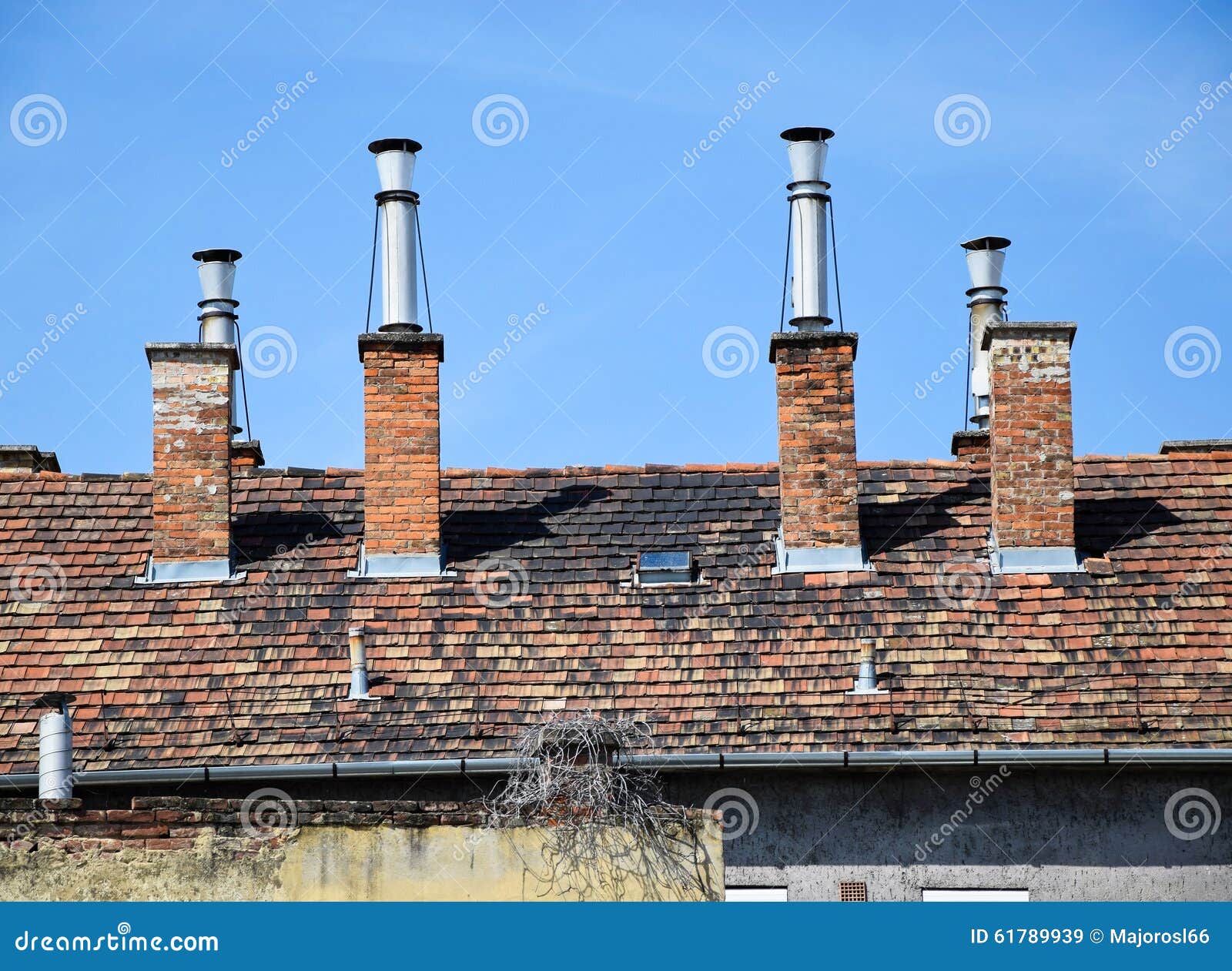 Smoke stacks on the roof stock image. Image of building - 61789939
