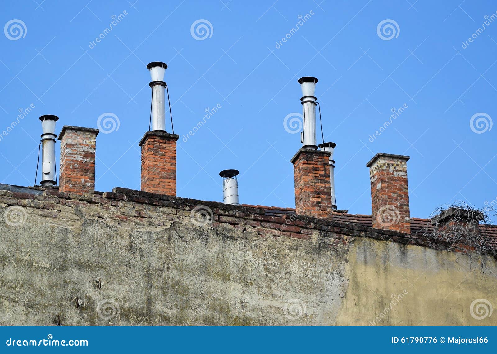 Smoke stacks on the roof stock photo. Image of house - 61790776