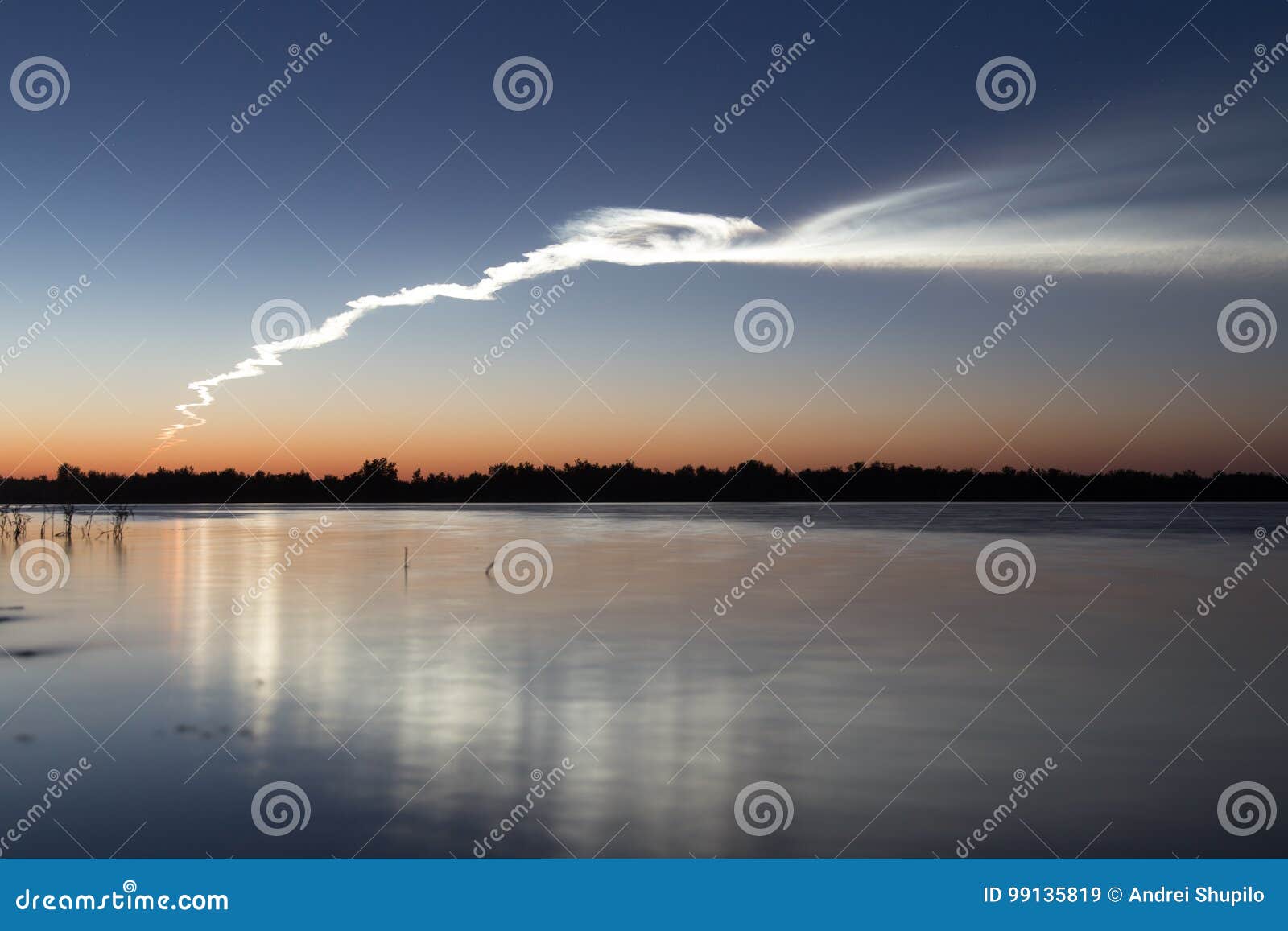 Smoke Trail from a Rocket at Sunset with Reflection in Water Stock ...