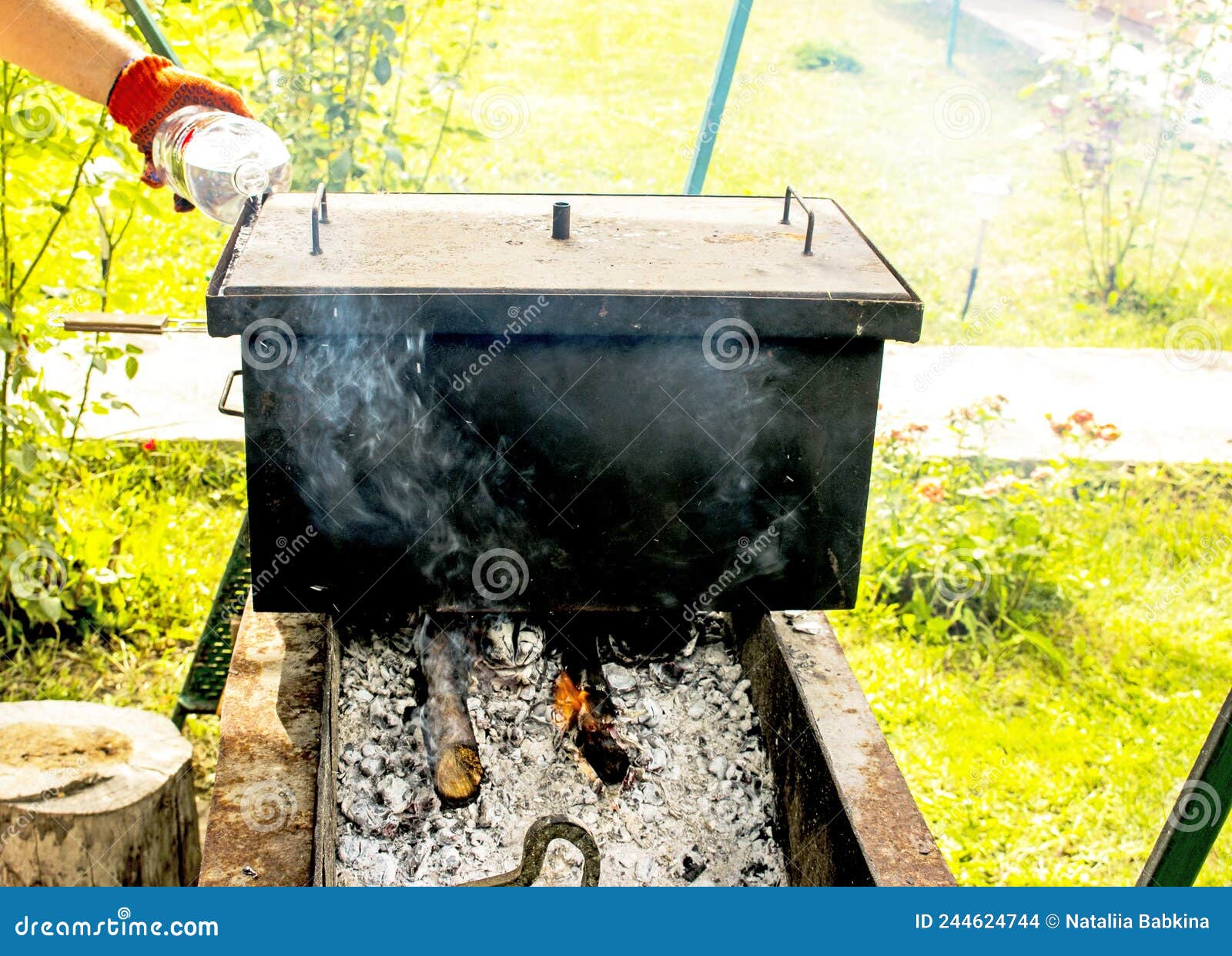 Smokehouse for Hot Smoking on Fire. a Man Pours Water into the Shutter ...