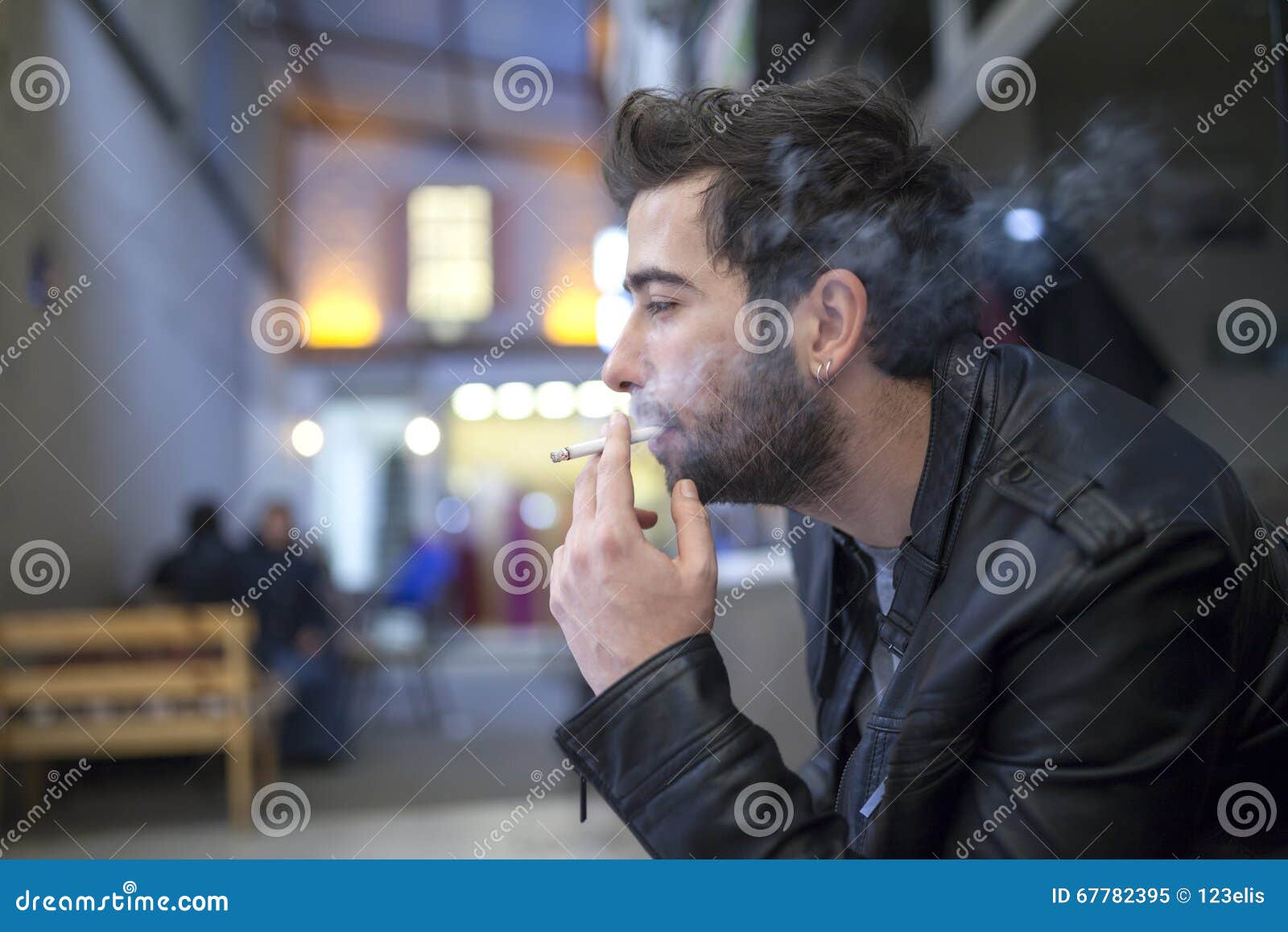 Smoker Young Man stock image. Image of sitting, handsome - 67782395