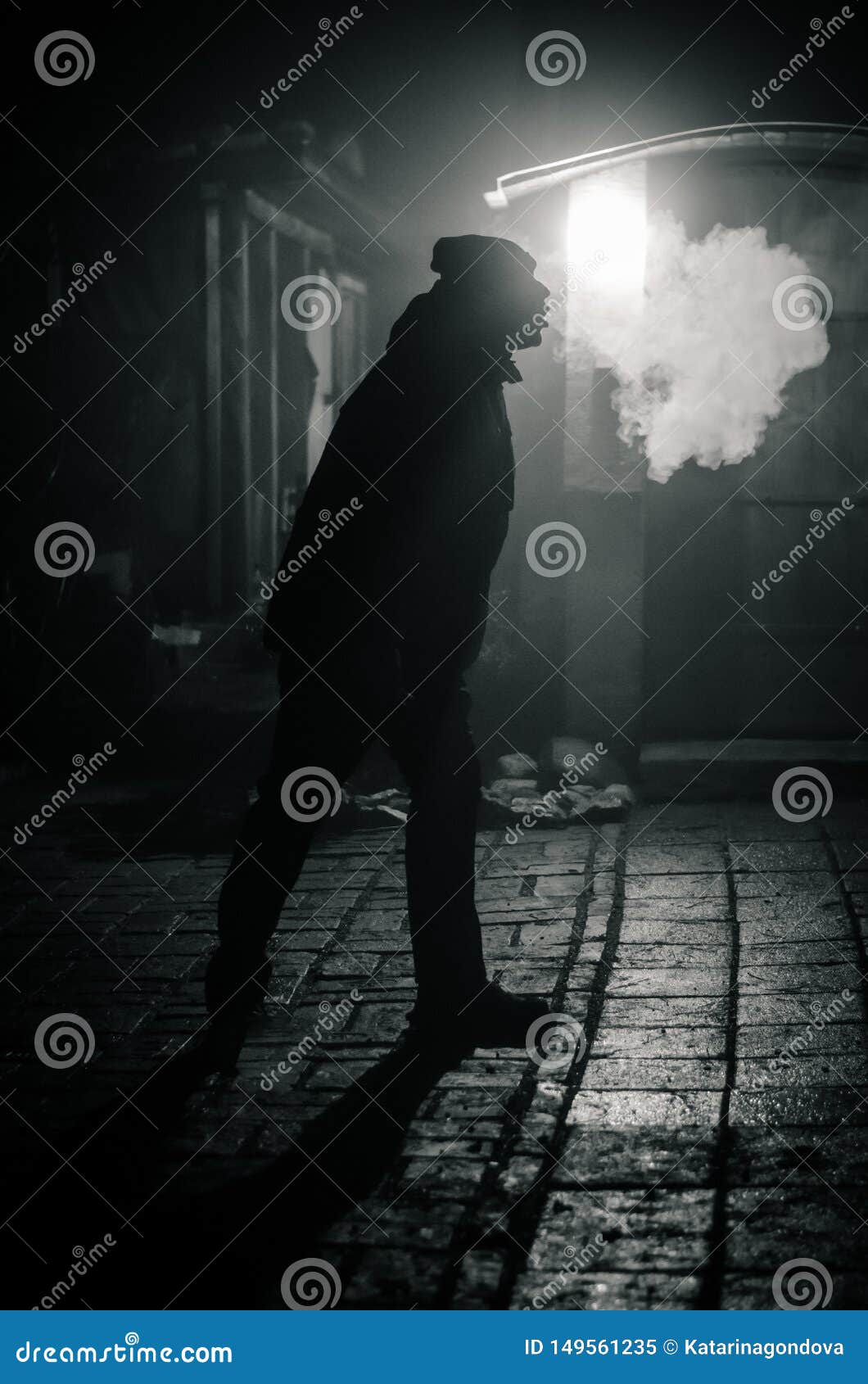 Smoking alone at night stock image. Image of contrast - 149561235