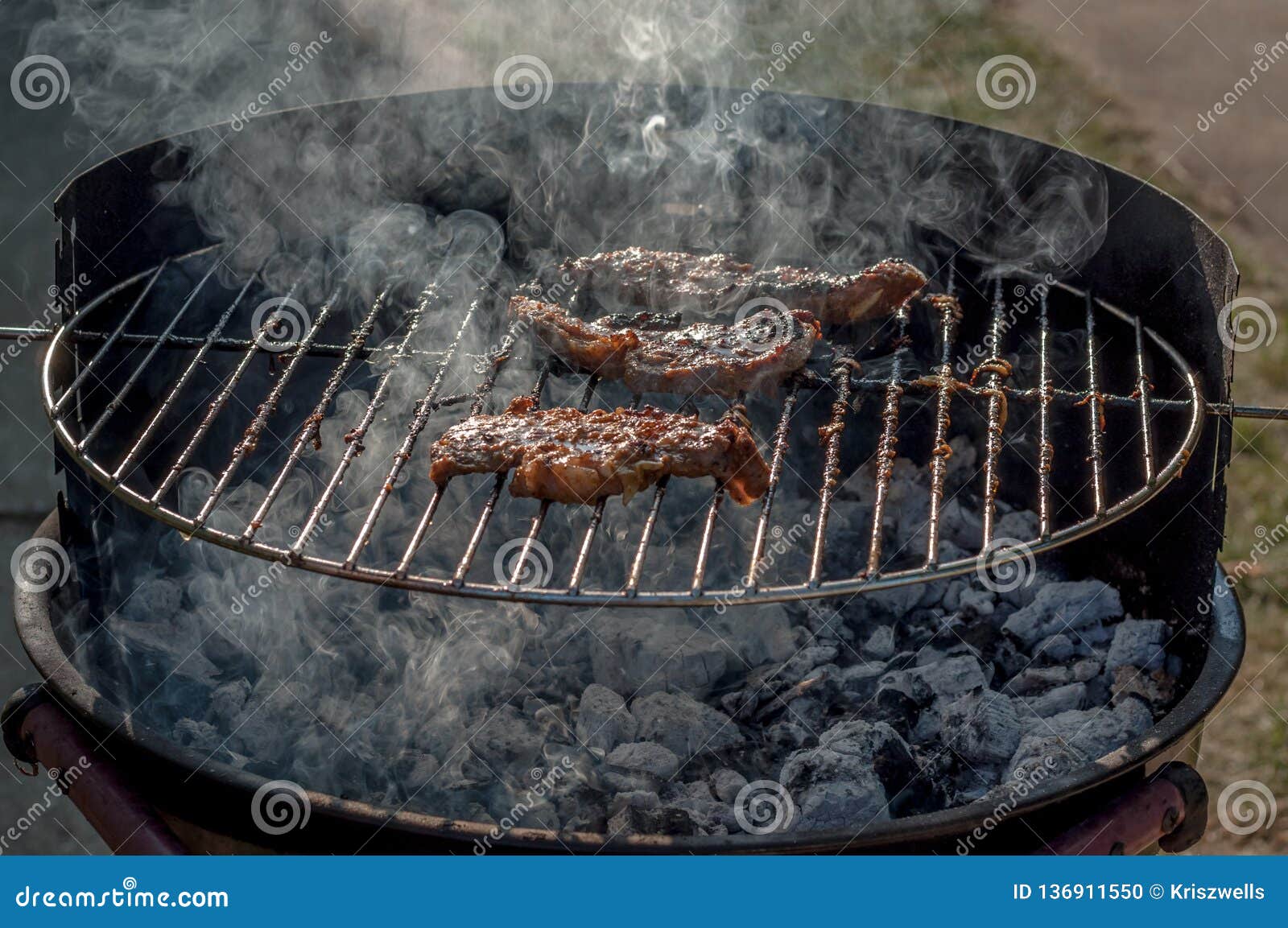 Smoking charcoal barbecue. stock photo. Image of cooking - 136911550