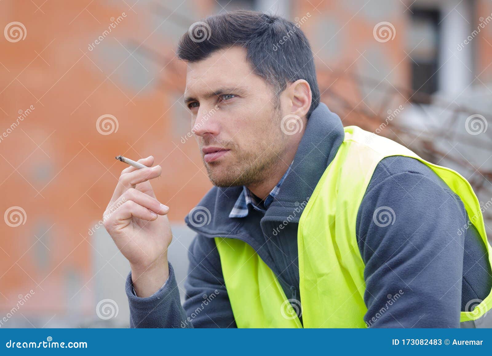 Smoking Cigarette on Construction Site Stock Image - Image of sitting ...