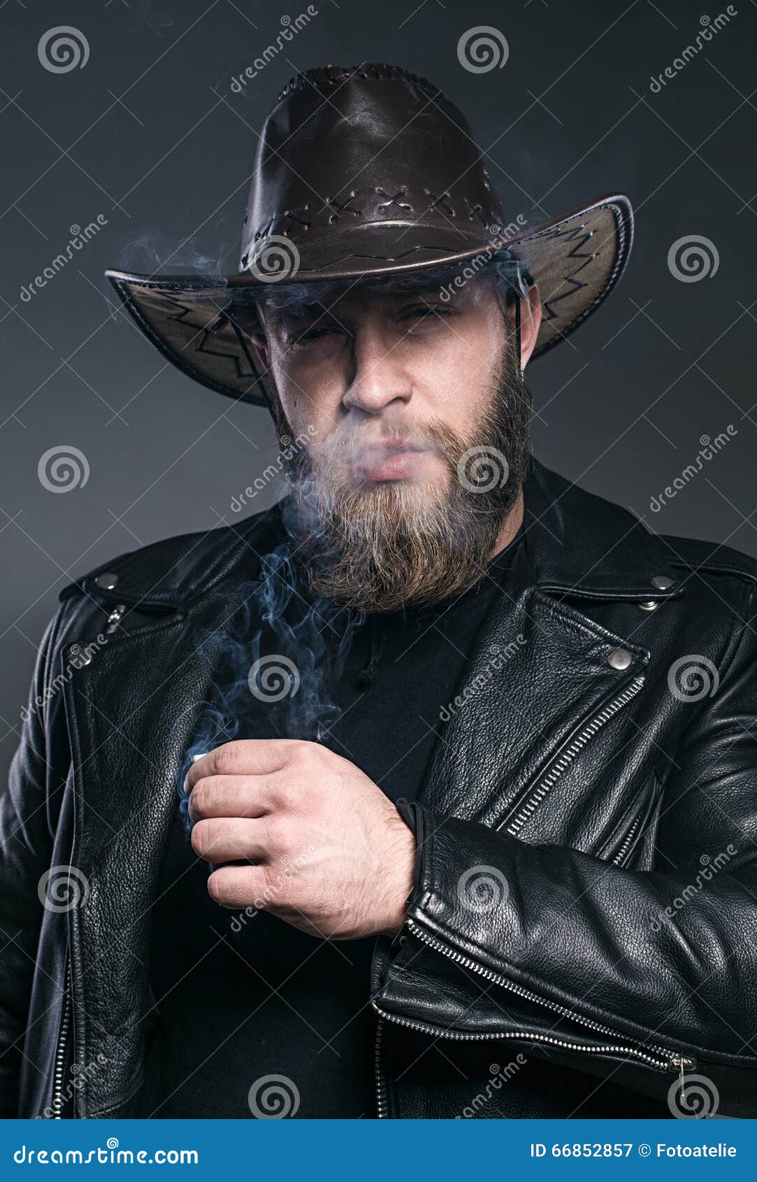Smoking Man with a Beard and Mustache Wearing a Cowboy Hat. Stock Image ...