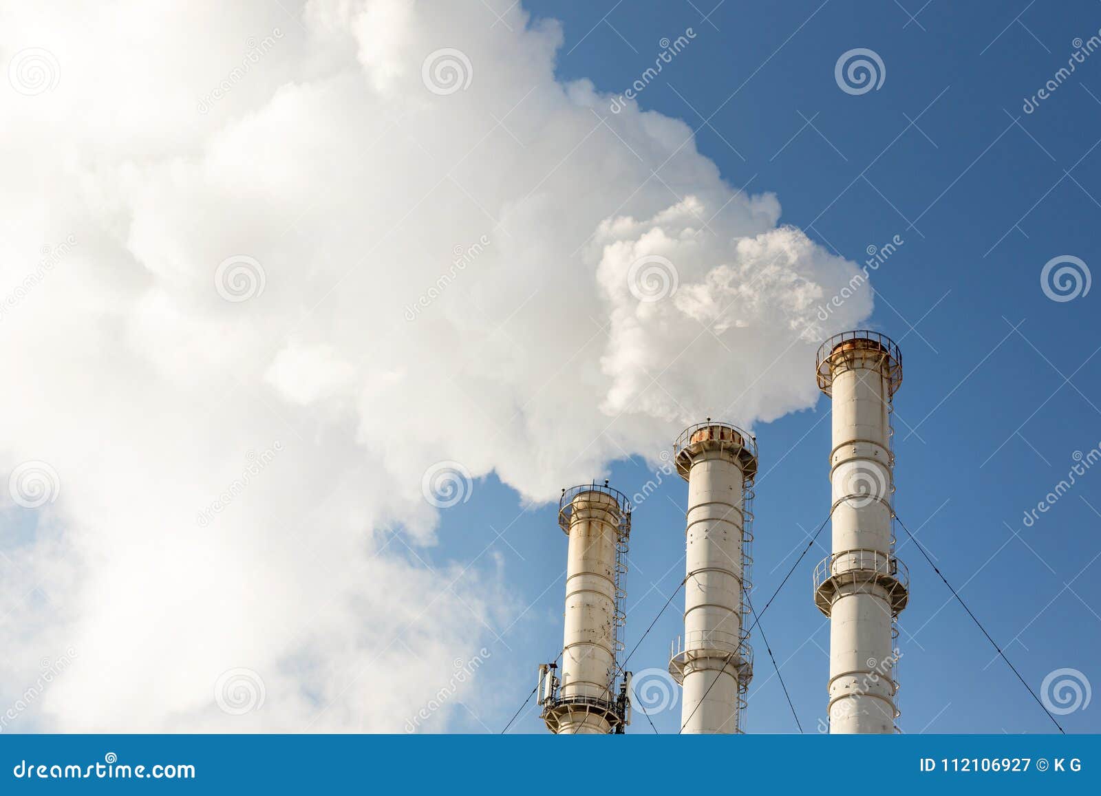 Smoking Pipes Making Clouds Against Blue Sky Background. Dioxide Air ...