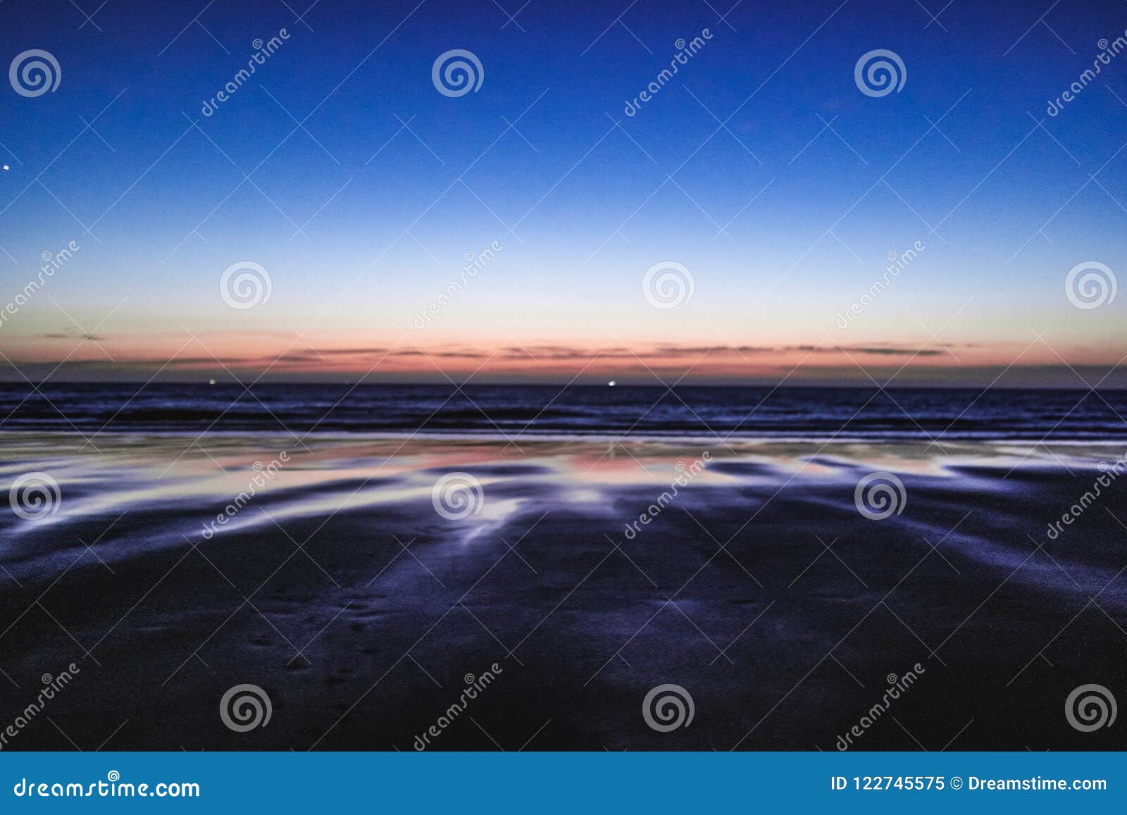 Smooth beach sunset stock image. Image of ocean, skies - 122745575
