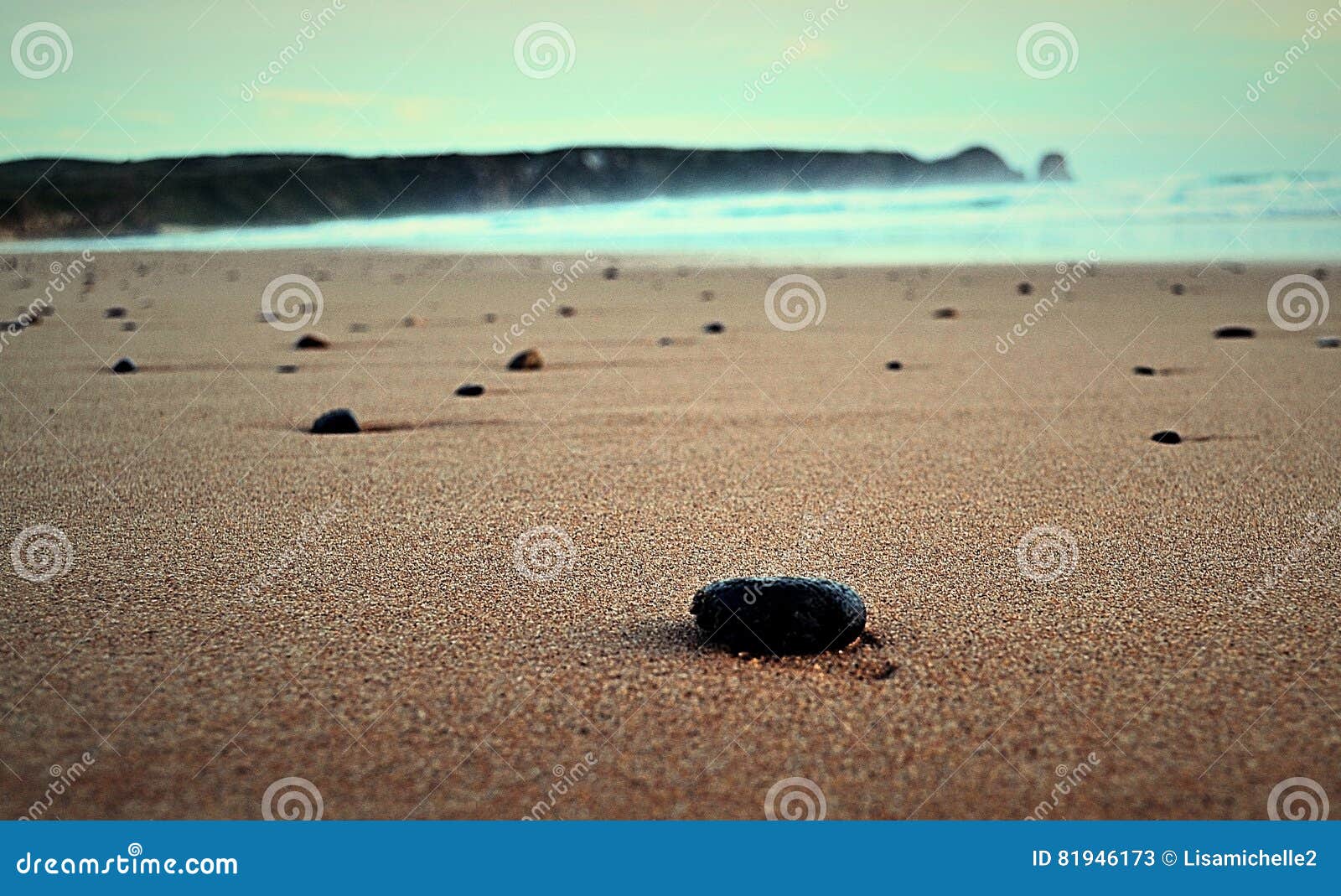 Smooth Black Stone on the Sand by the Ocean Stock Image - Image of ...