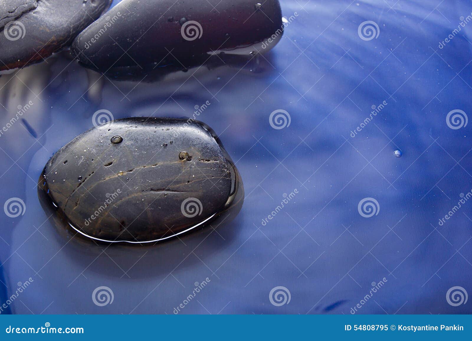 Smooth stones in water stock image. Image of blue, stone - 54808795