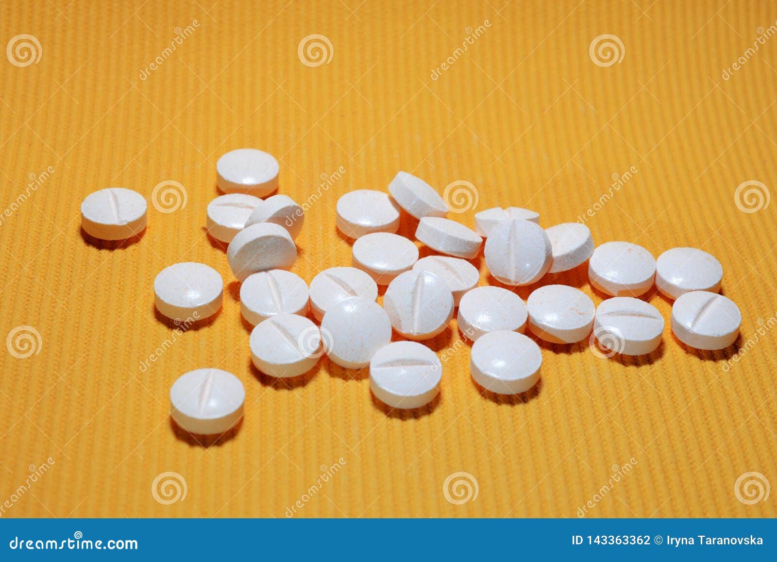 Smooth White Convex Tablets with a Dividing Strip on a Yellow Striped ...