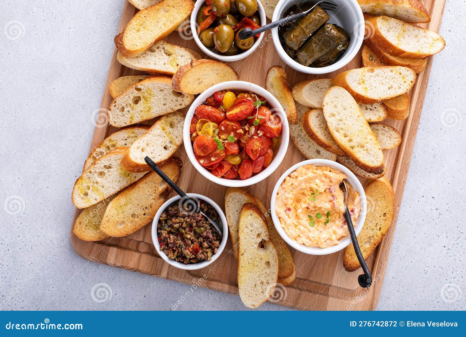 Snack Board with Toasted Baguette and Variety of Dips Stock Photo ...