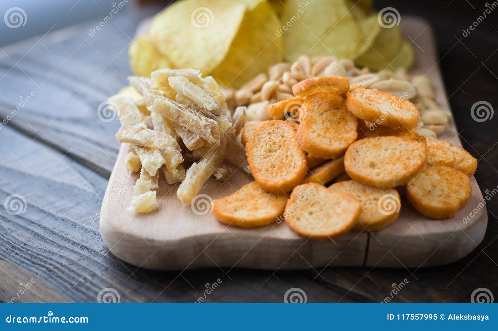 Snacks for Beer on the Table in the Pub. Peanuts, Pieces of Fish ...