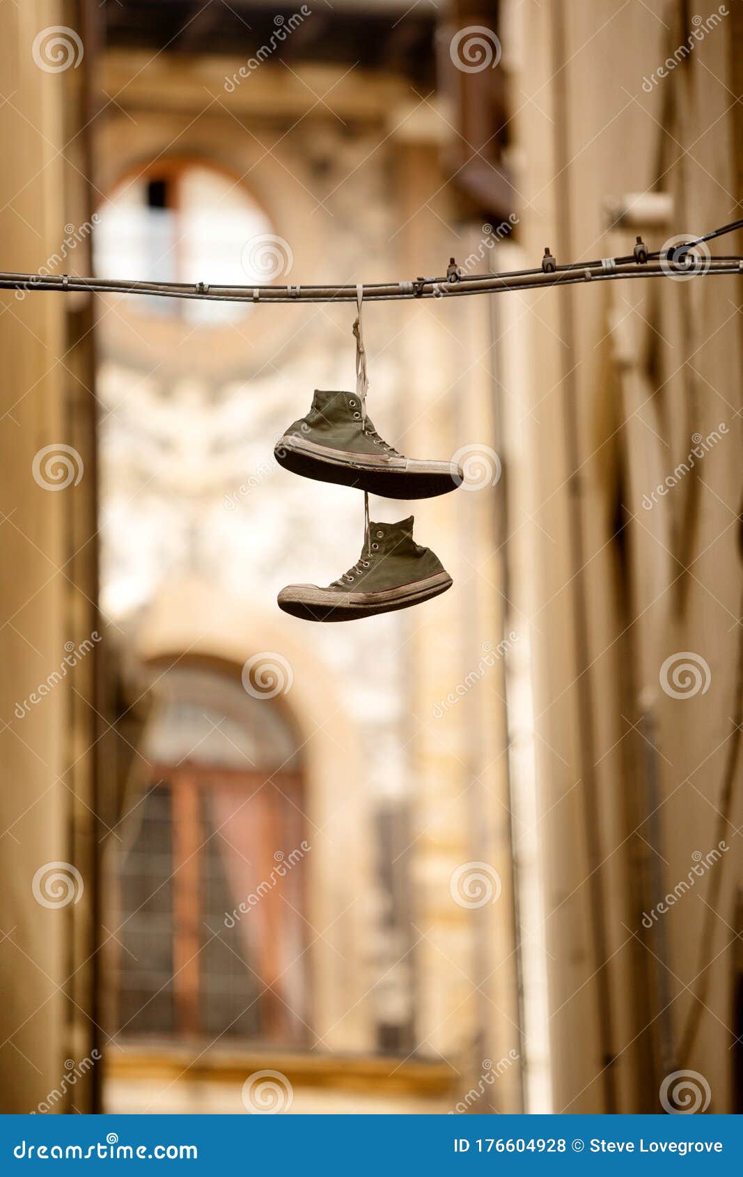 Sneakers Hanging Overhead on Power Lines Stock Photo - Image of ...