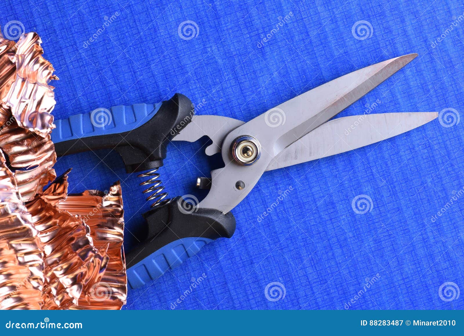 Snip Cutter and Copper Scrap on Blue Background Stock Image - Image of ...