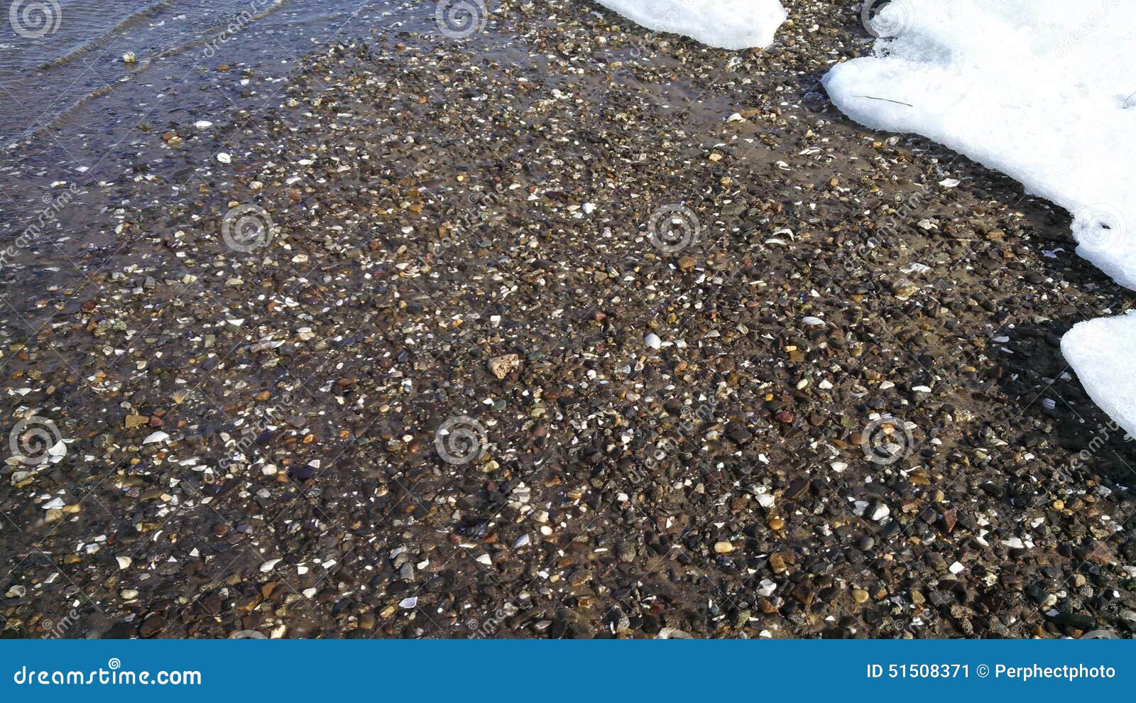 Snow on beach of pebbles stock image. Image of melting - 51508371