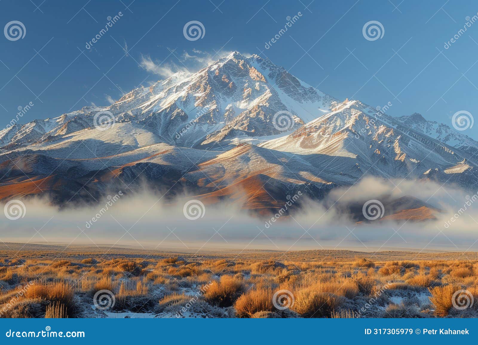 Snow-capped Mountains Fading into Mist, with a Lightly Clouded Sky ...