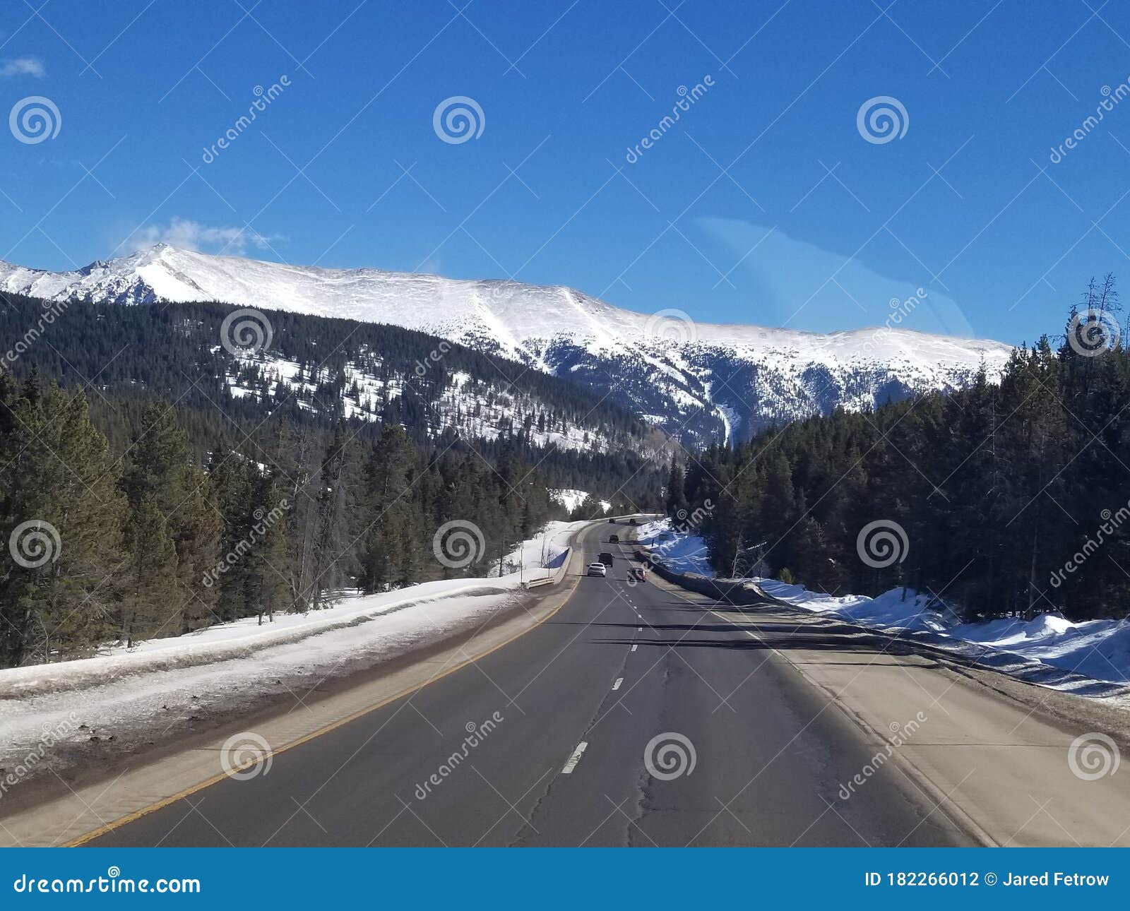 Snow Capped Rocky Mountain High Stock Photo - Image of driving, freeway ...