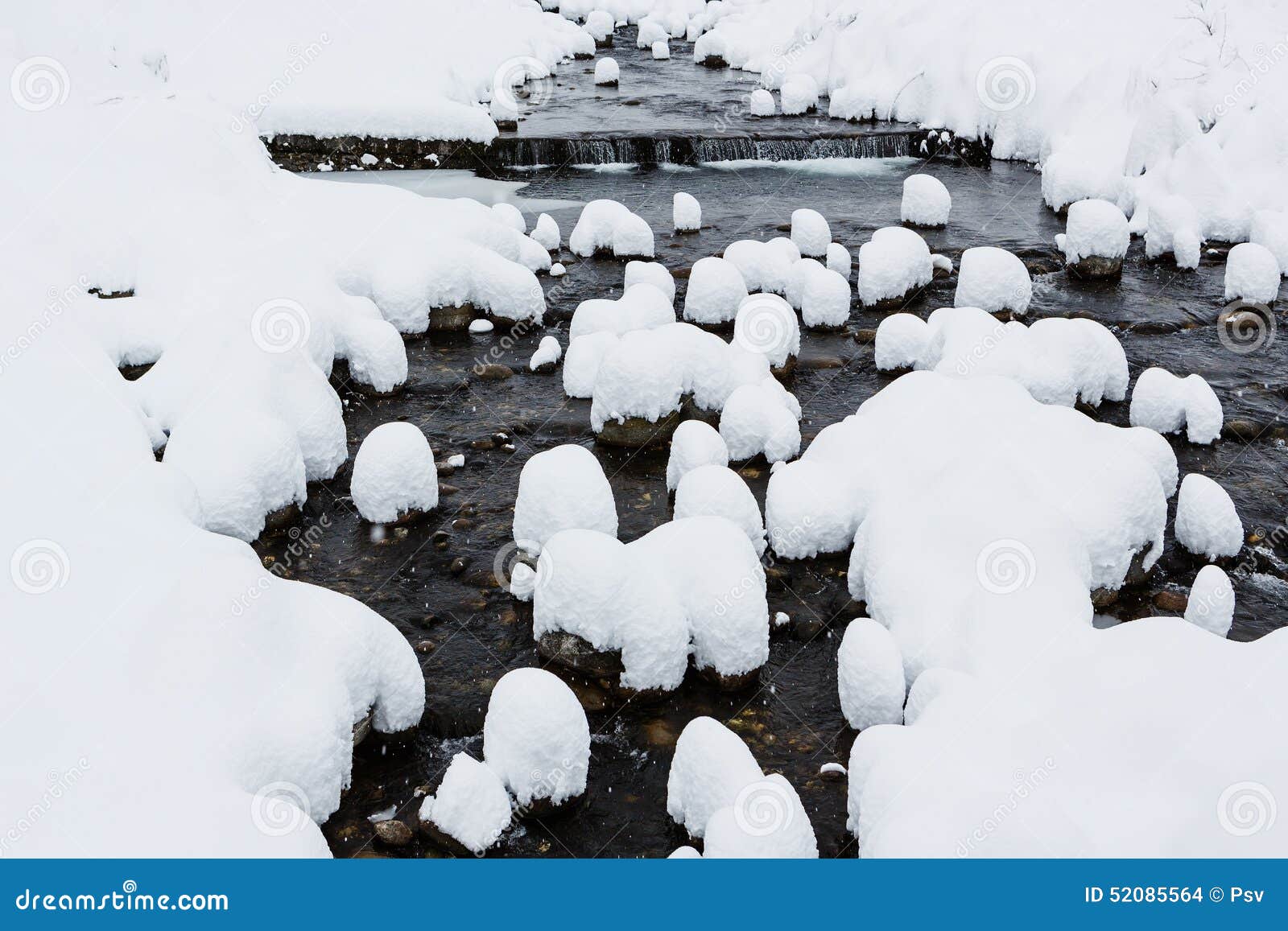 Snow Caps on Boulders in the Mountain River Stock Photo - Image of ...
