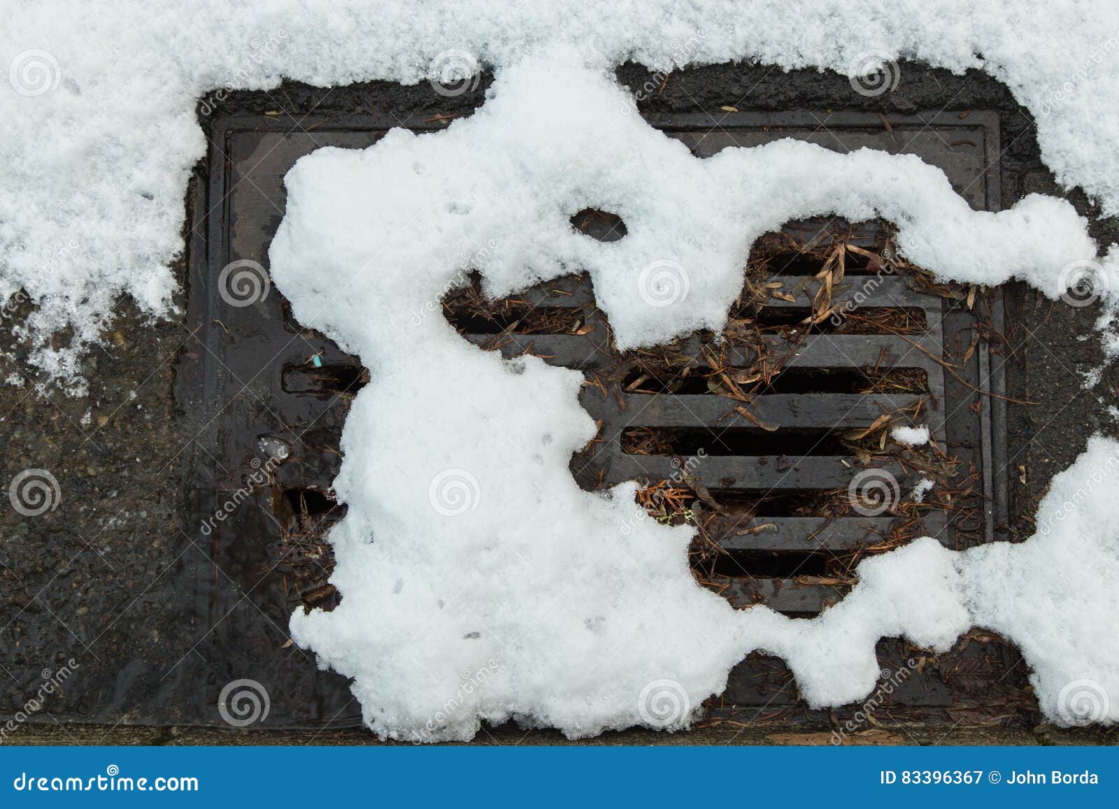 Snow clogged street drain stock image. Image of reflection - 83396367