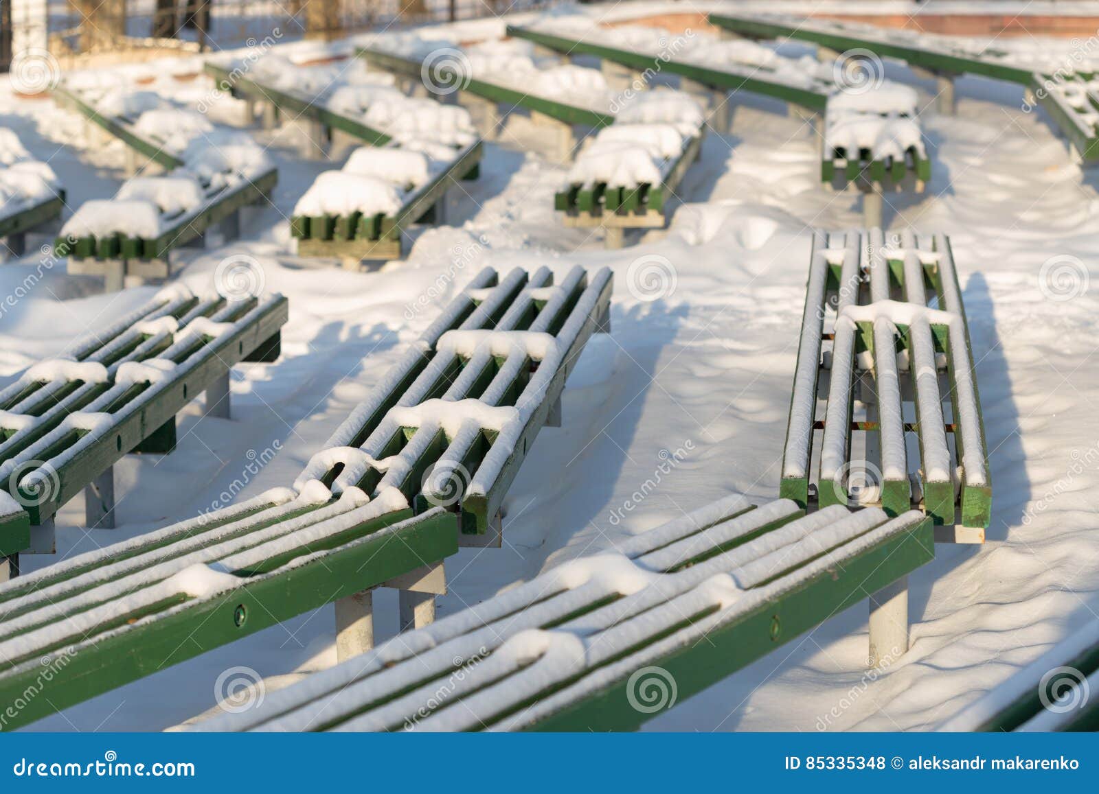 Snow Covered Bench in Winter Amusement Park Stock Photo - Image of ...