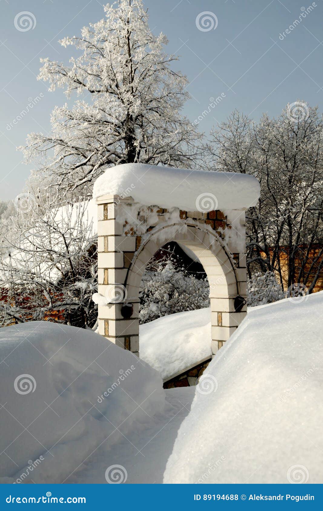 Snow-covered Brick Arch Amidst Snowdrifts with Footpath Stock Photo ...