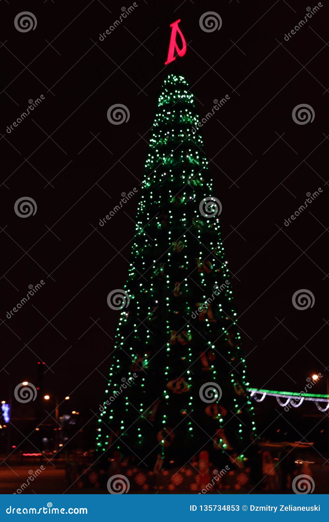 Snow Covered Christmas Tree with Multi Colored Lights at Night Stock ...