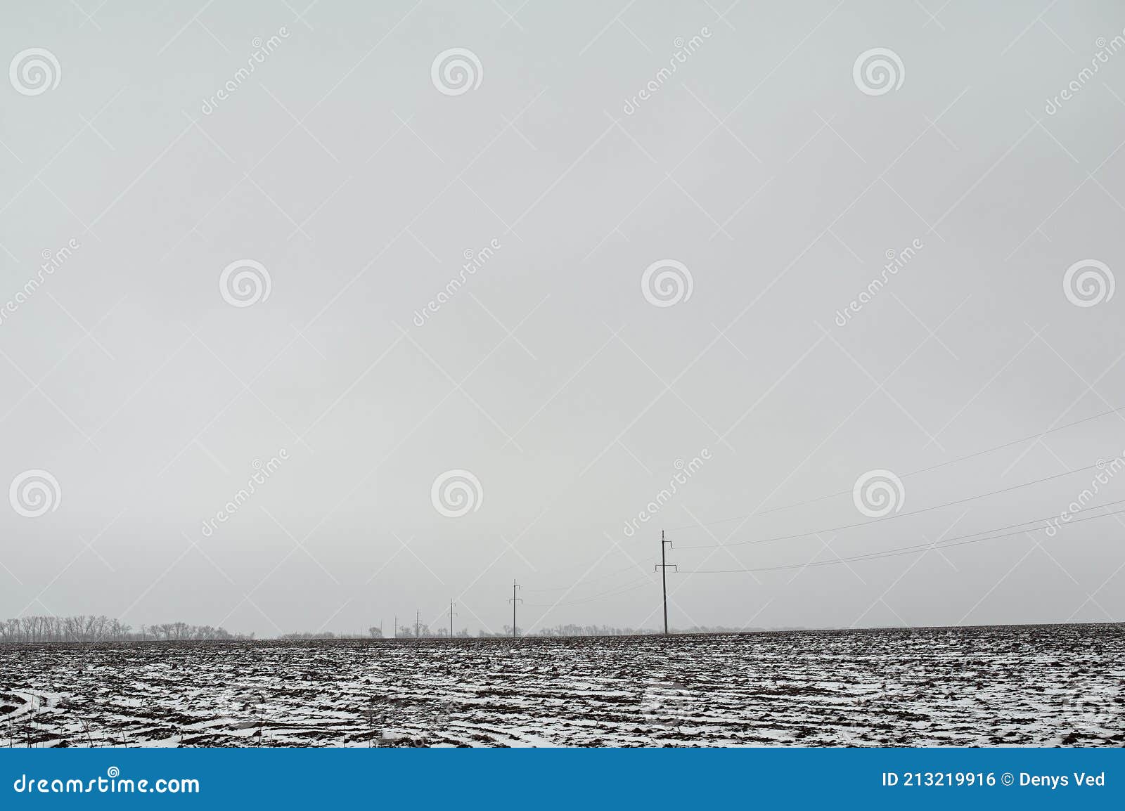 Snow Covered Field with Power Line Pillar with Cloudy Sky Stock Photo ...