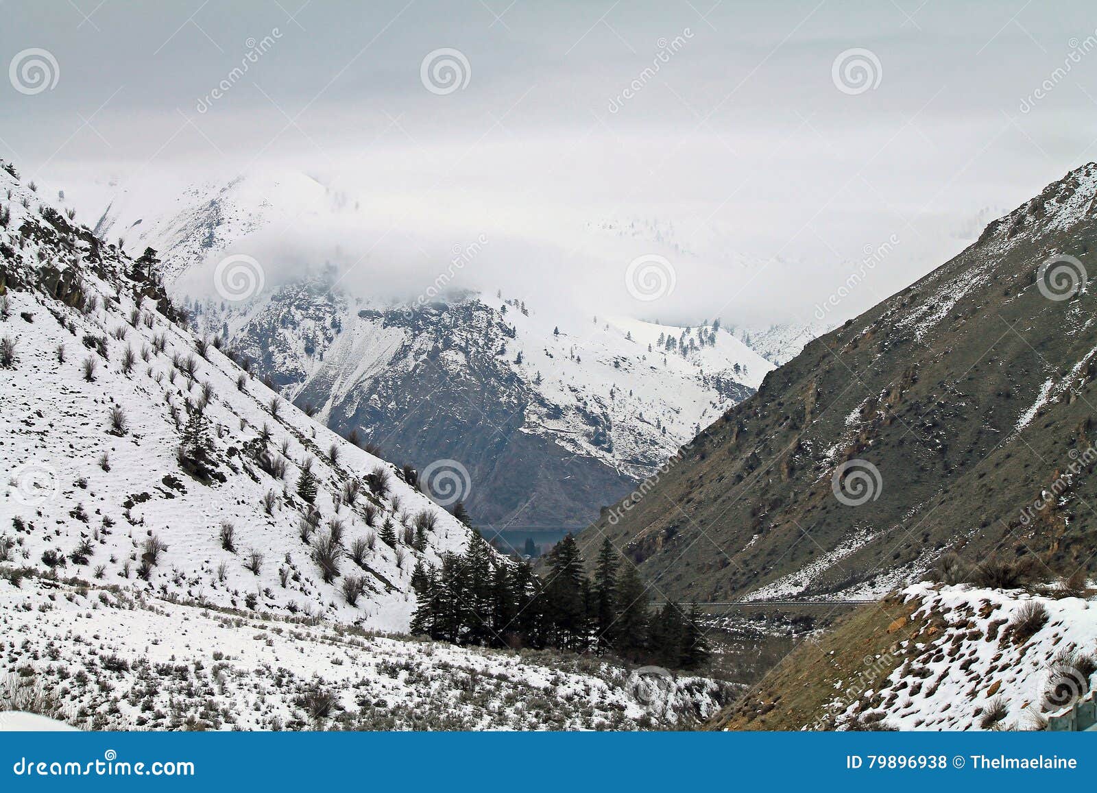 Snow Covered Mountain Pass Overlooking Granite Peaks Stock Photo ...