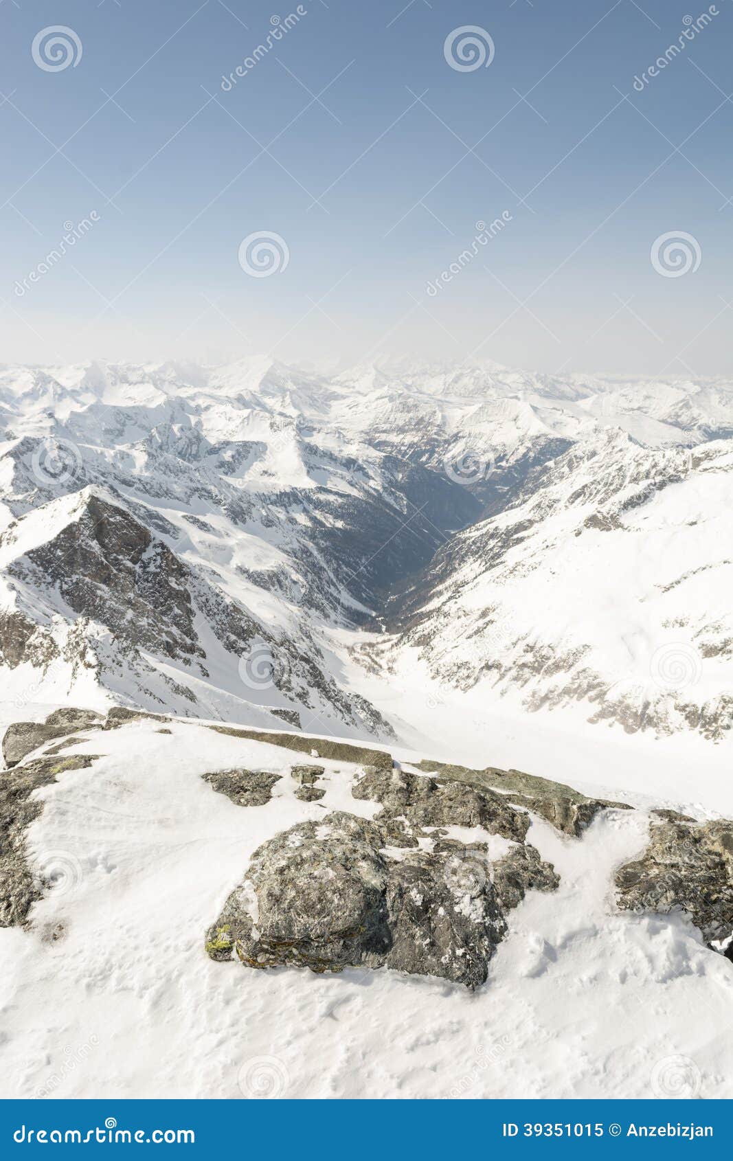 Snow Covered Rock with a Mountain Valley in the Back Stock Image ...