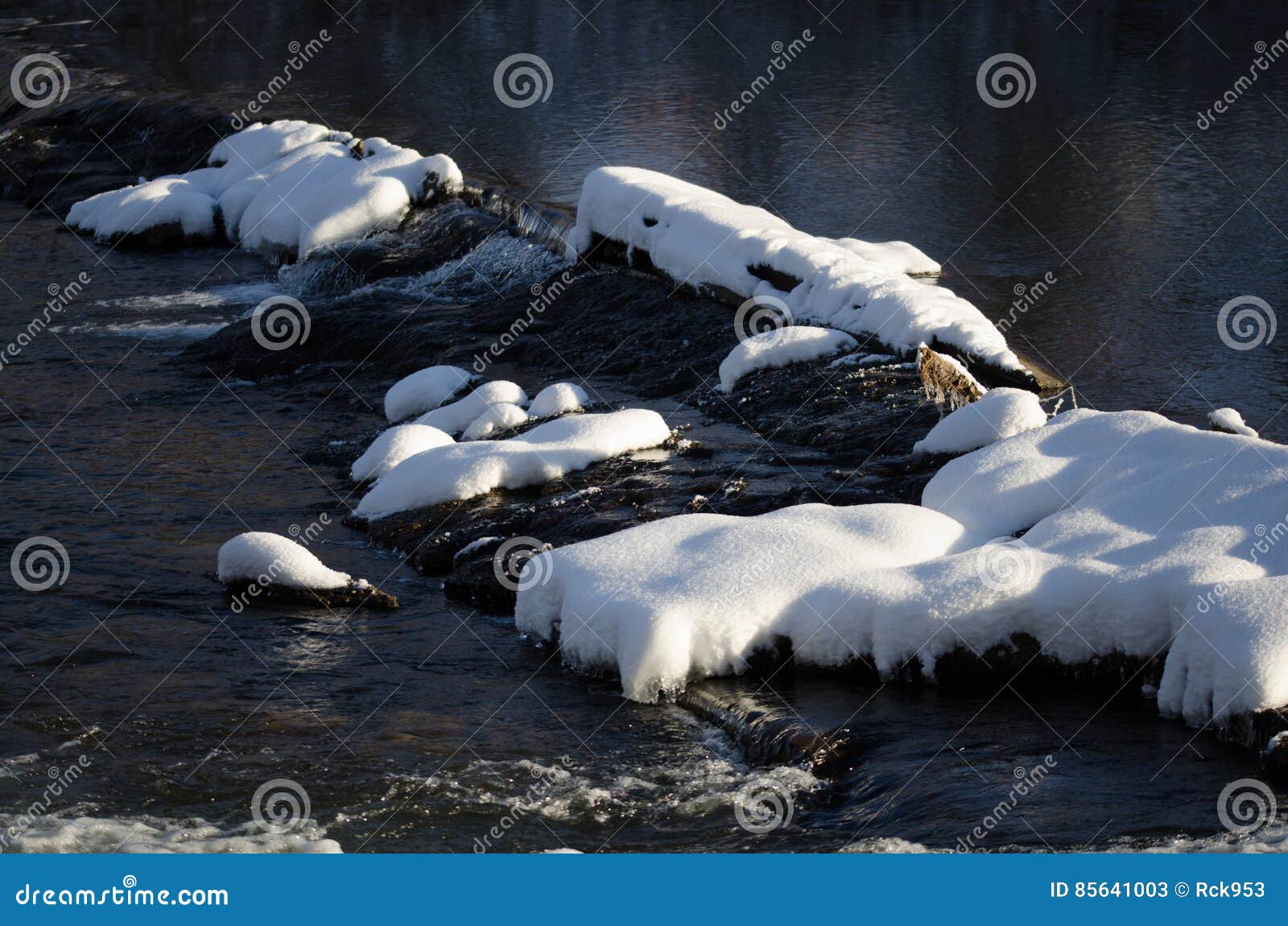 Snow Covered Rocks Forming Dam Across the Cold Winter River Stock Image ...