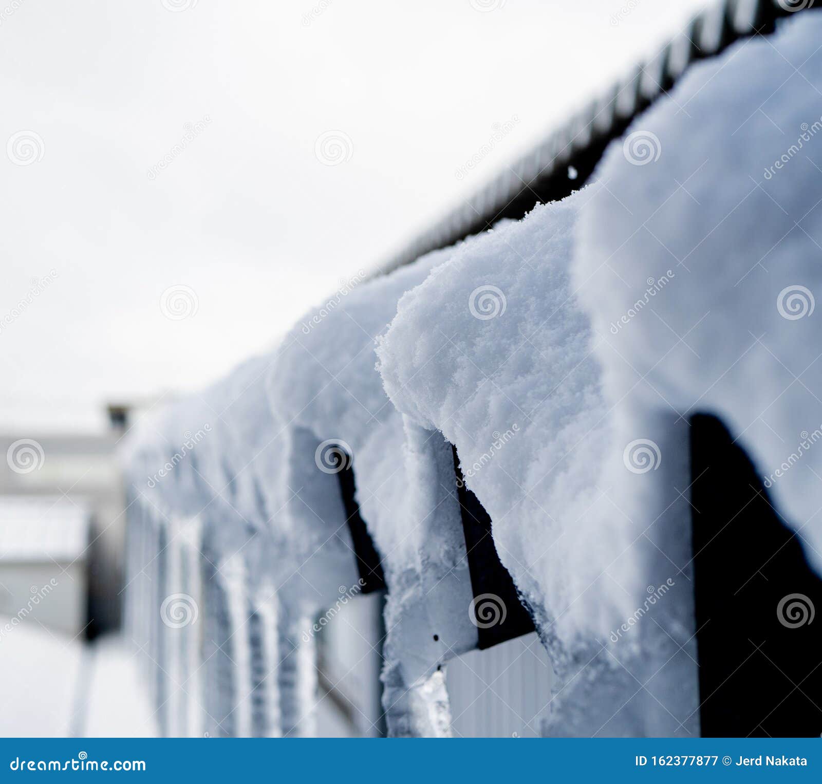 Snow curtain at the eaves. stock image. Image of architecture - 162377877