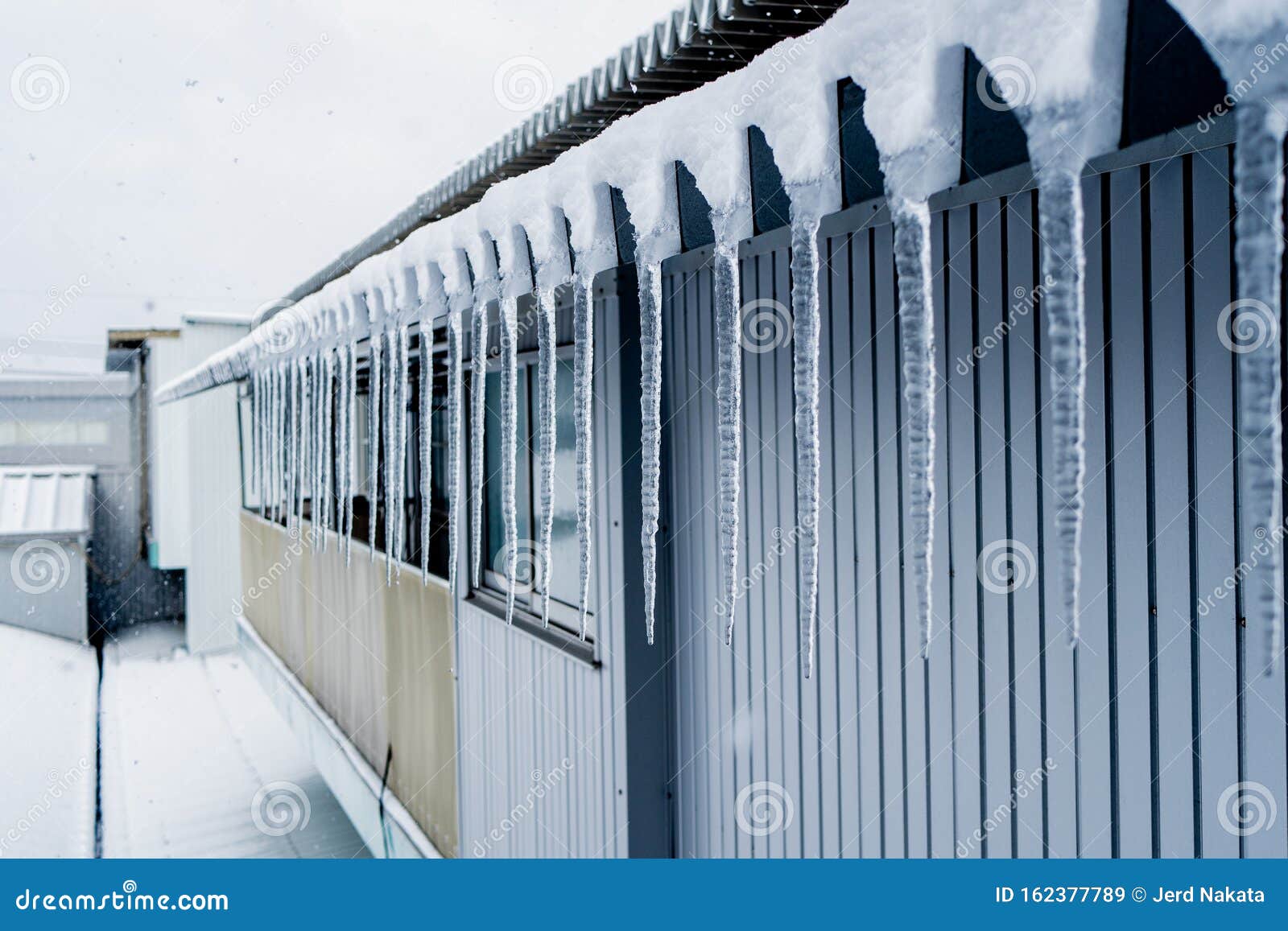 Snow curtain at the eaves. stock image. Image of bright - 162377789
