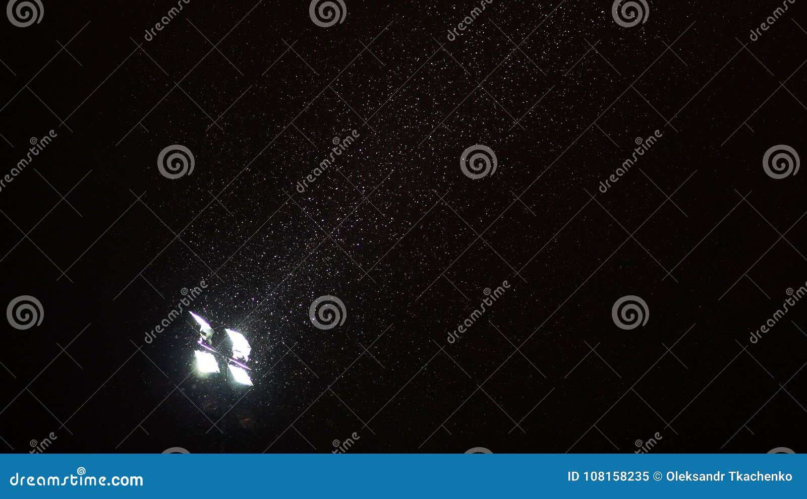 Snow is Falling through the Beam of Searchlight in Night Sky. Stock ...