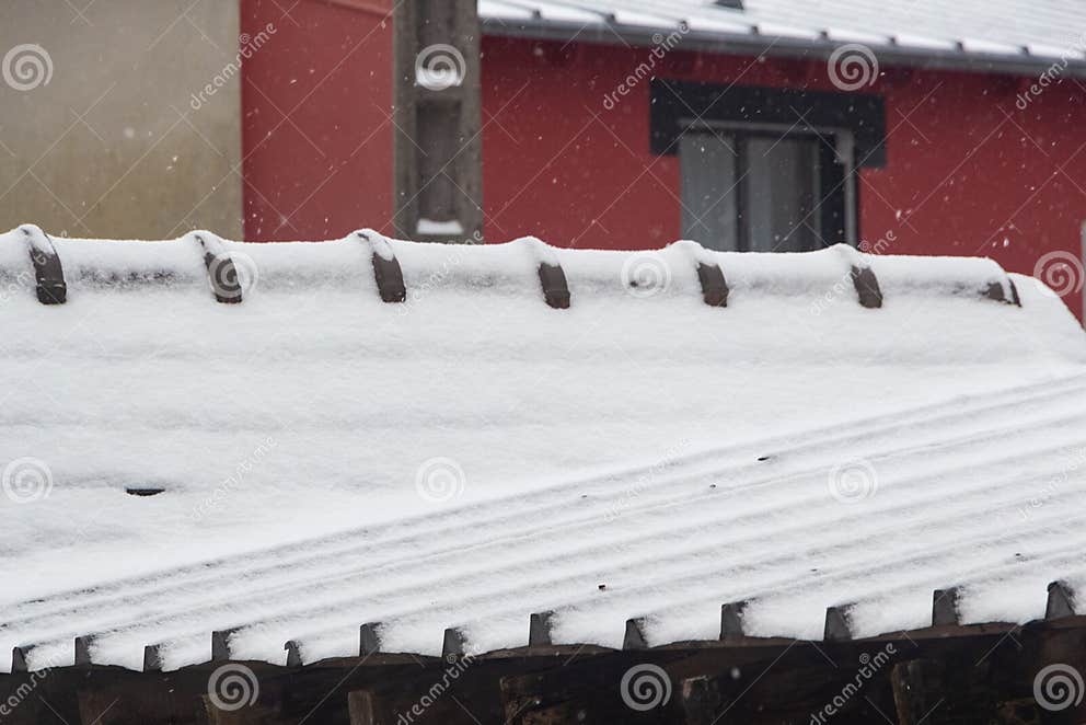 Snow falling on a roof stock photo. Image of city, weather - 215598032