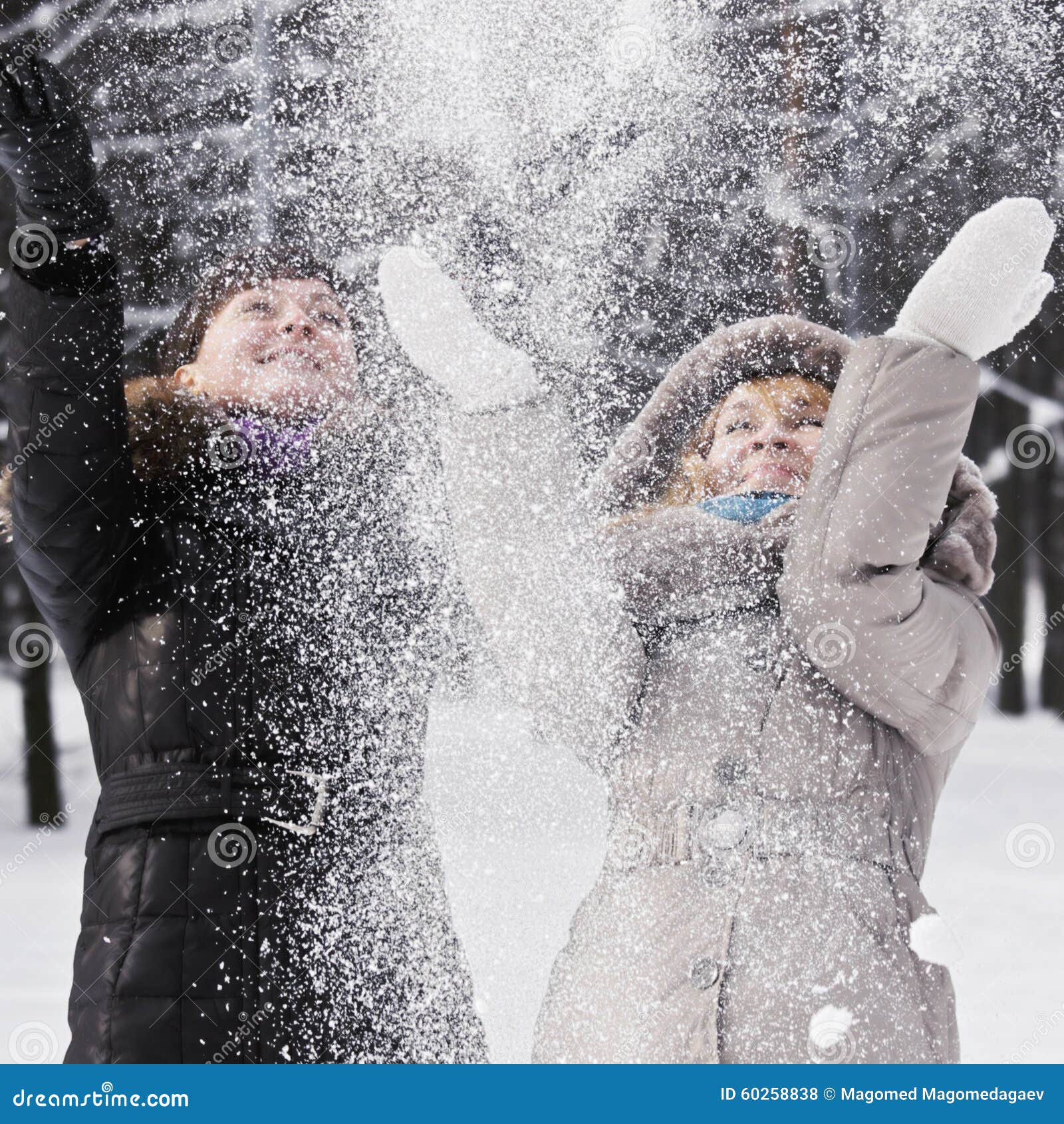 Snow falling from tree stock photo. Image of jacket, winter - 60258838