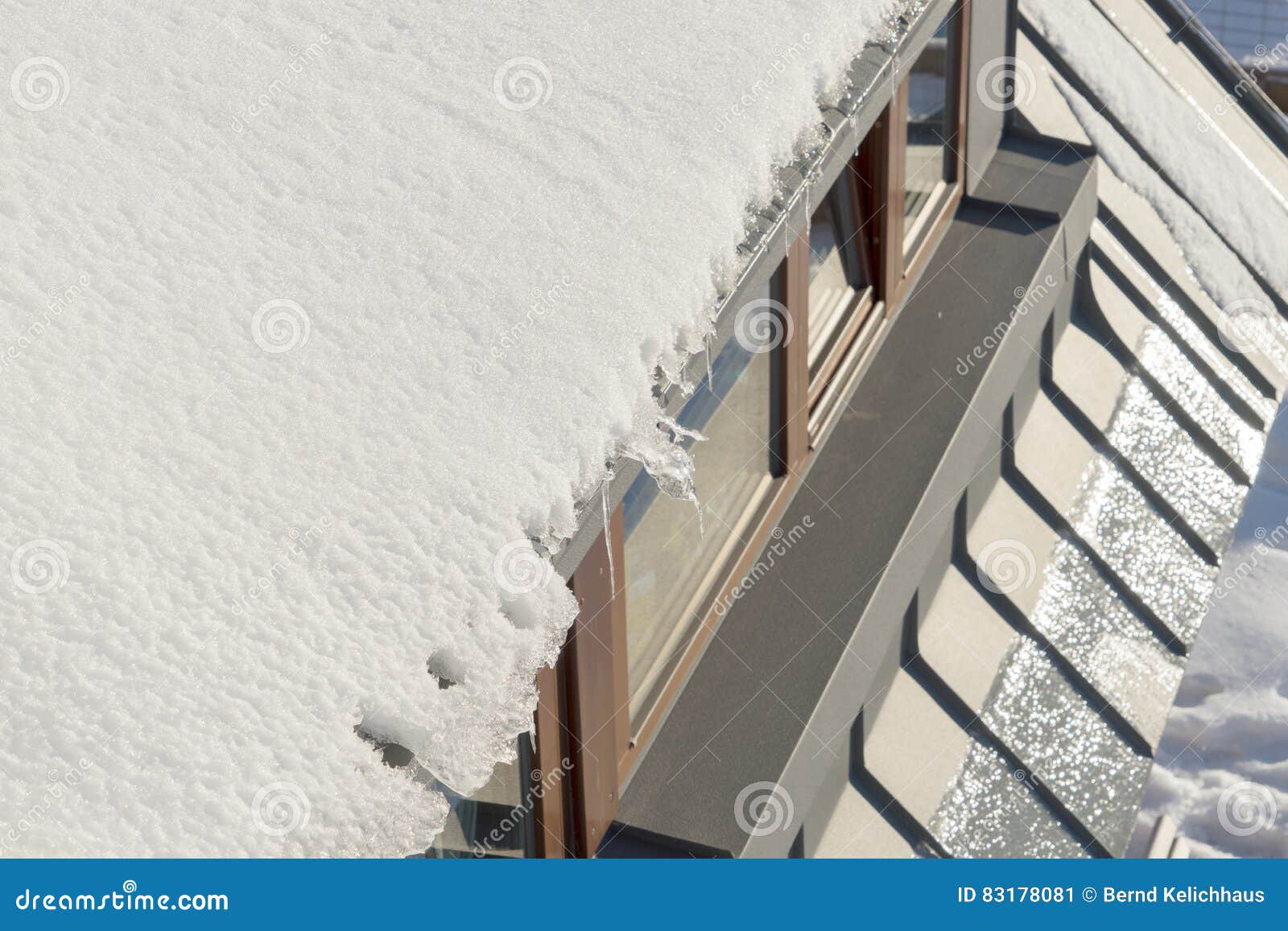 Snow hanging on the roof stock image. Image of residence - 83178081