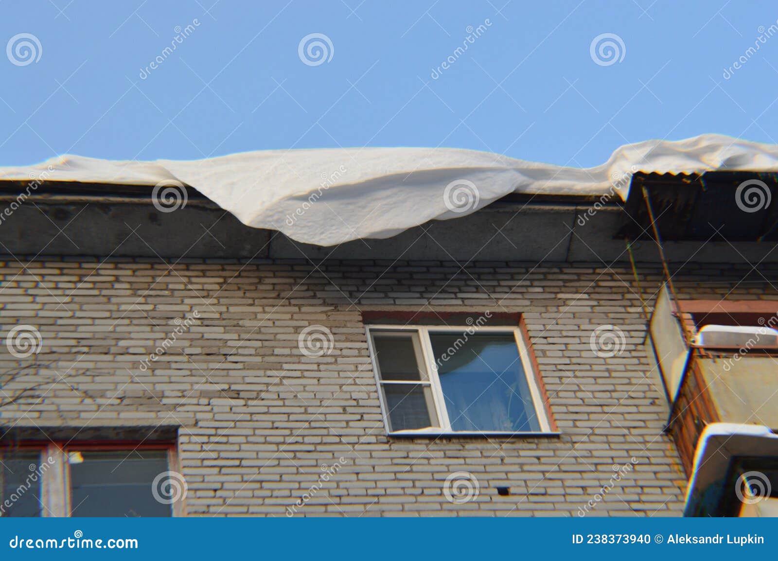 Snow Hanging from the Roof of a Five-storey House Stock Photo - Image ...