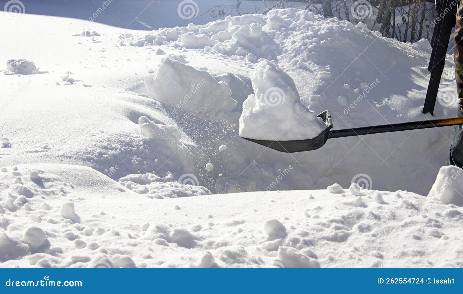 Snow Removal by a Person in Winter. Clearing the Sidewalk from Snow ...